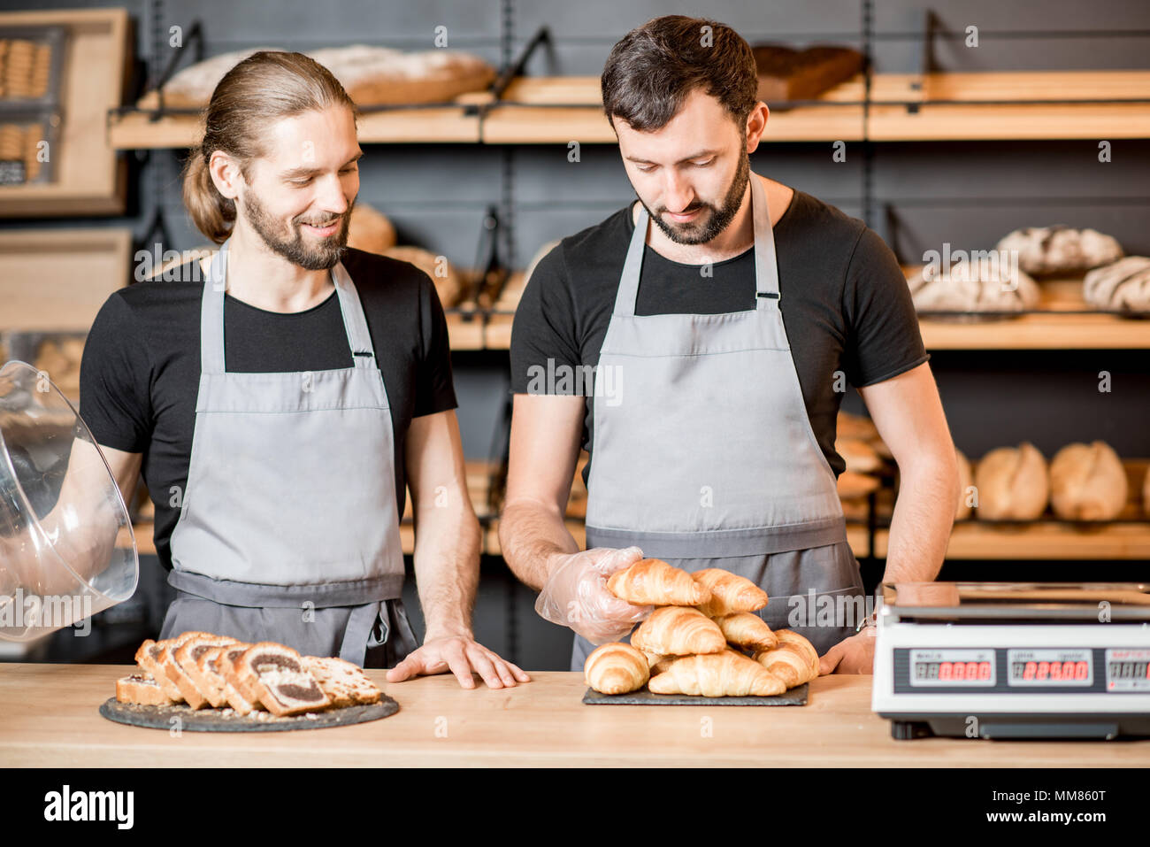 Bread sellers working at the bakery shop Stock Photo - Alamy