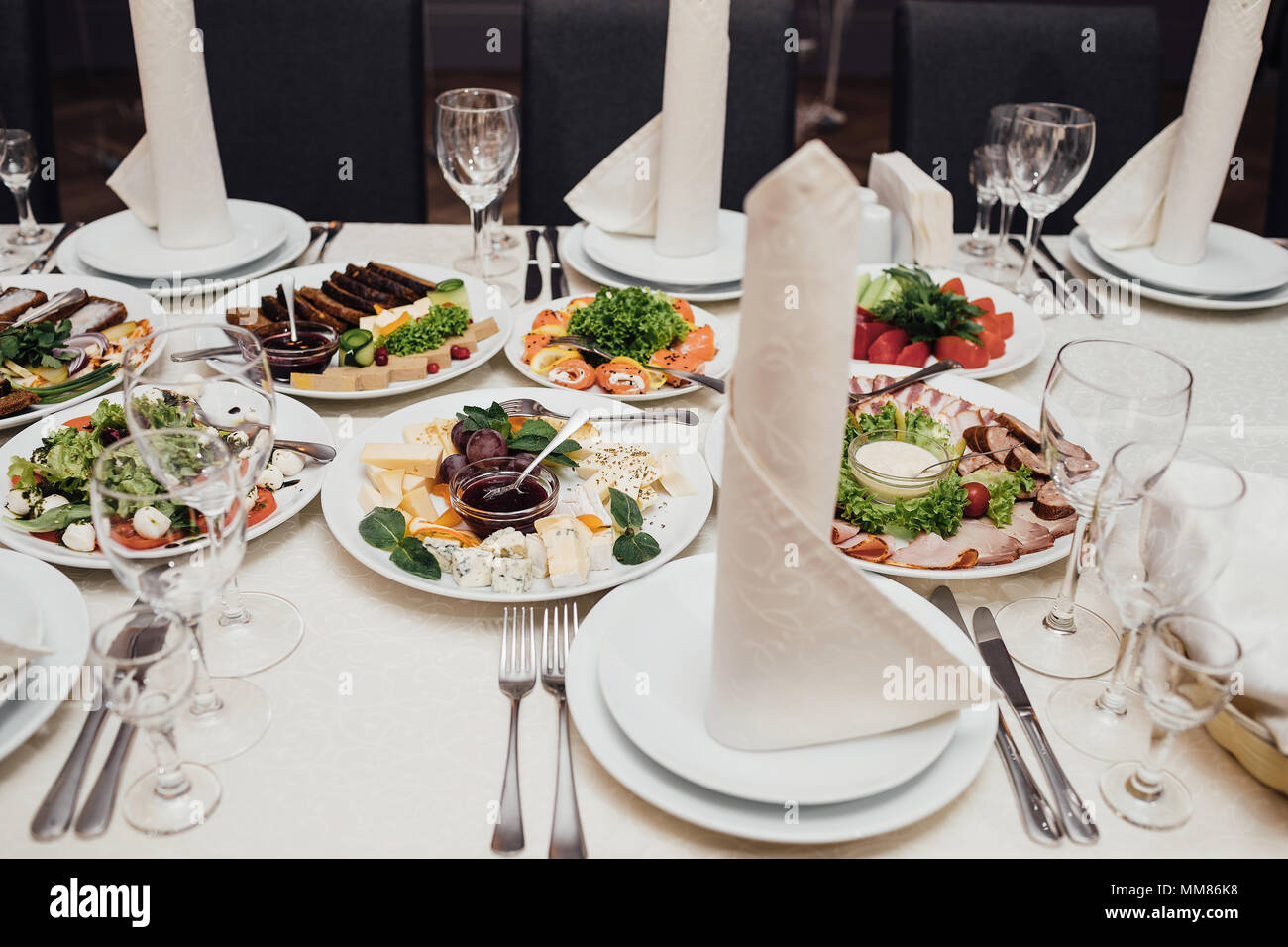 catering table set service with silverware and glass stemware at ...