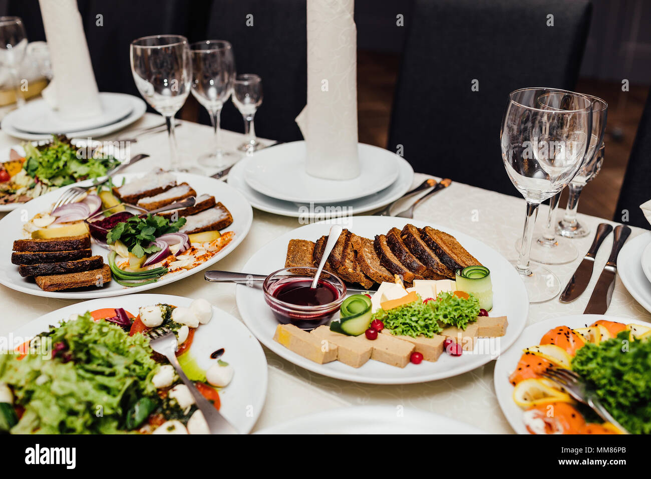 catering table set service with silverware and glass stemware at ...