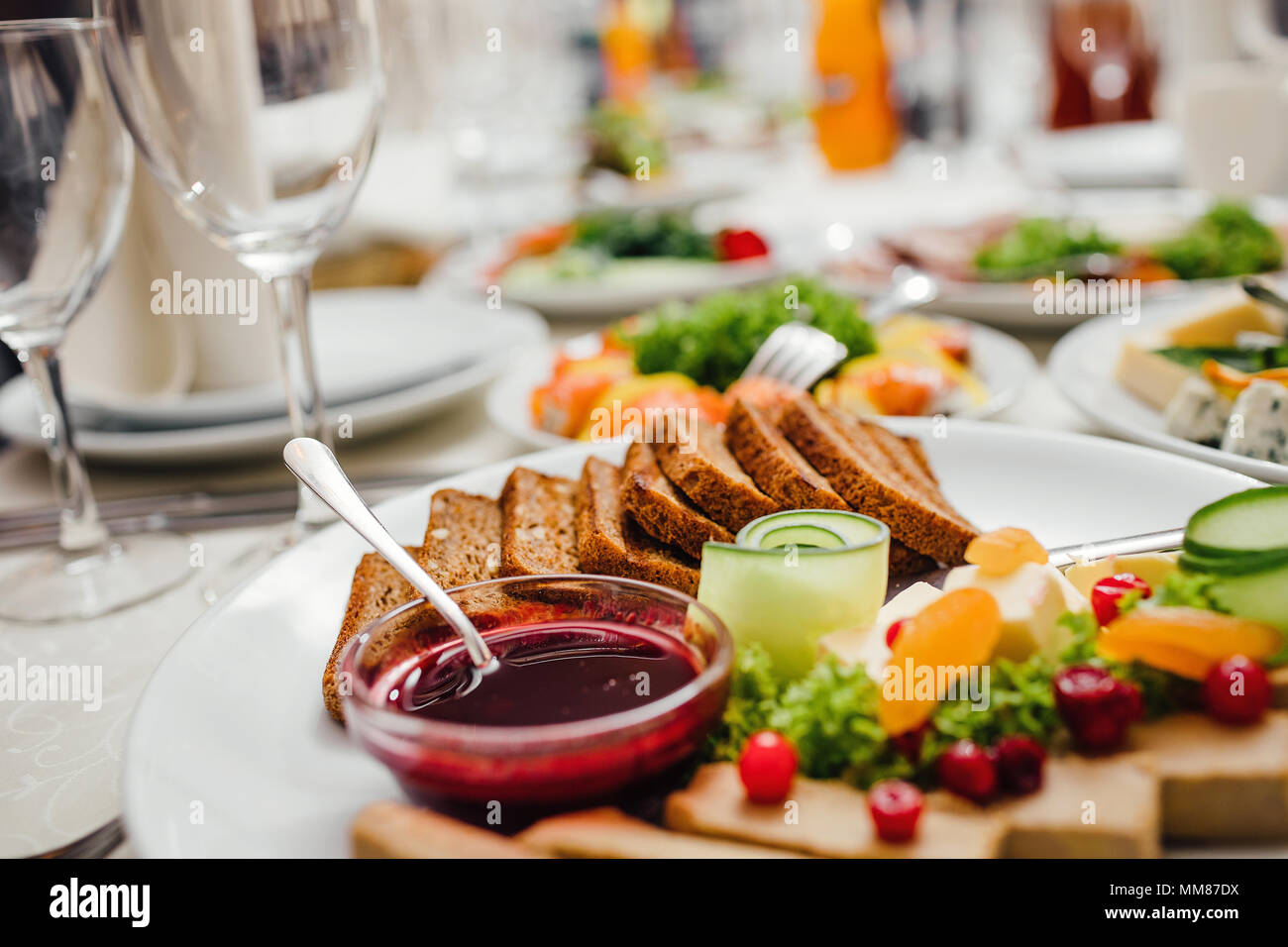catering table set service with silverware and glass stemware at ...