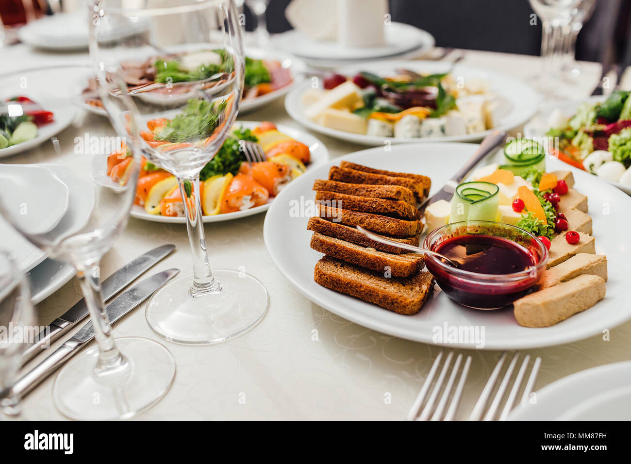 catering table set service with silverware and glass stemware at ...