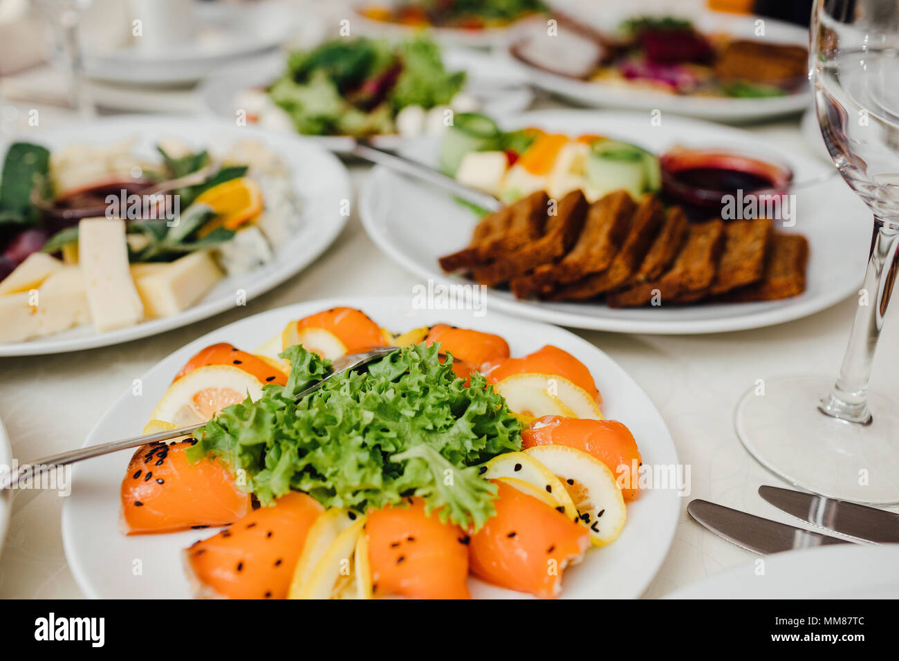 catering table set service with silverware and glass stemware at ...