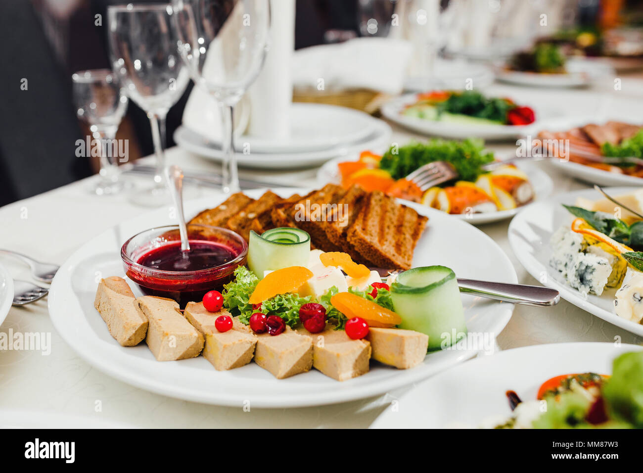 catering table set service with silverware and glass stemware at ...