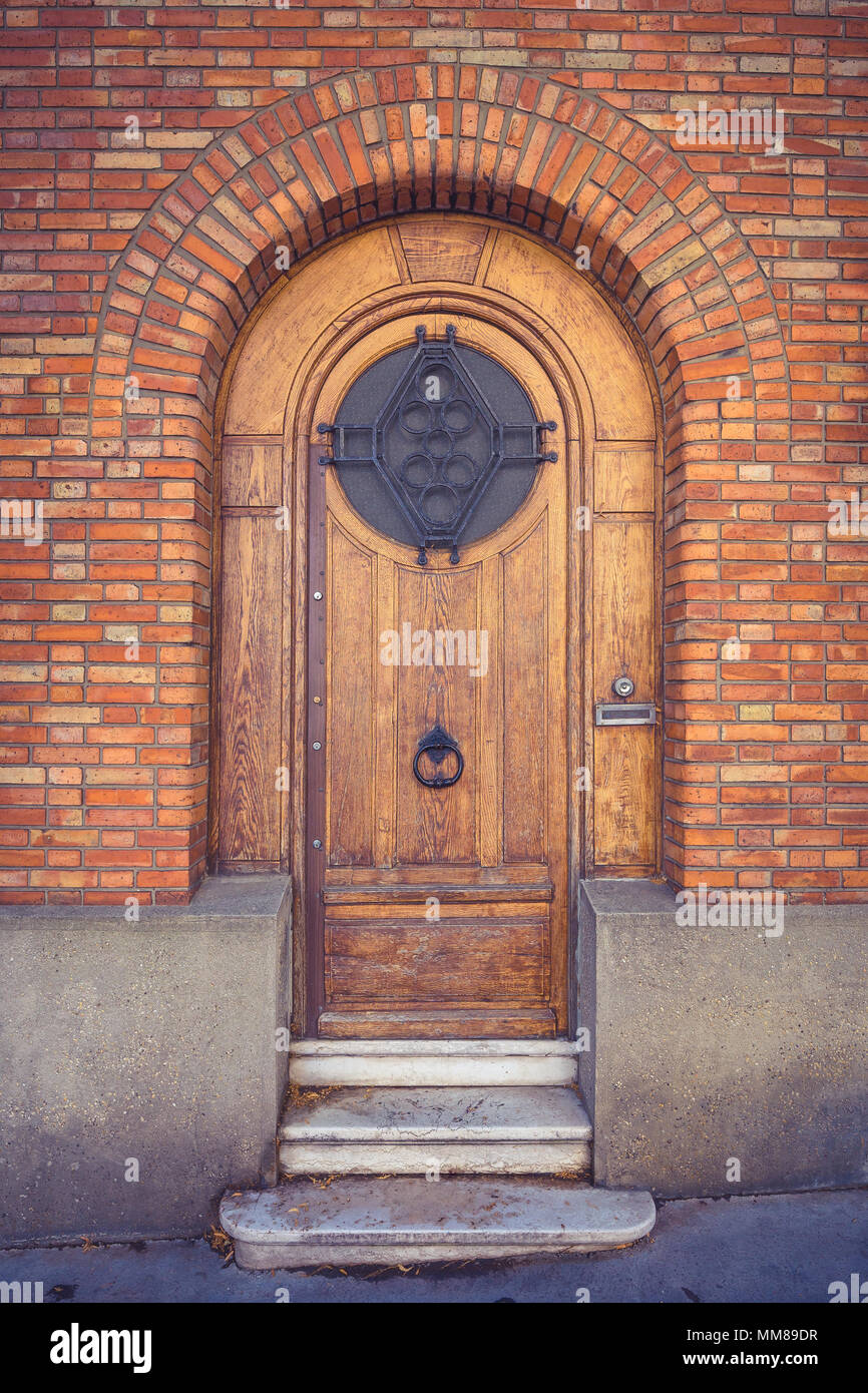 Old wooden door in brick wall Stock Photo - Alamy