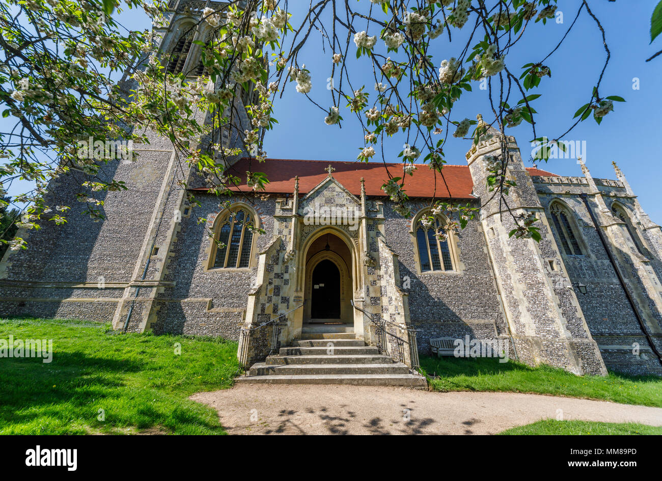 Traditional flint-faced parish church of St John the Evangelist ...