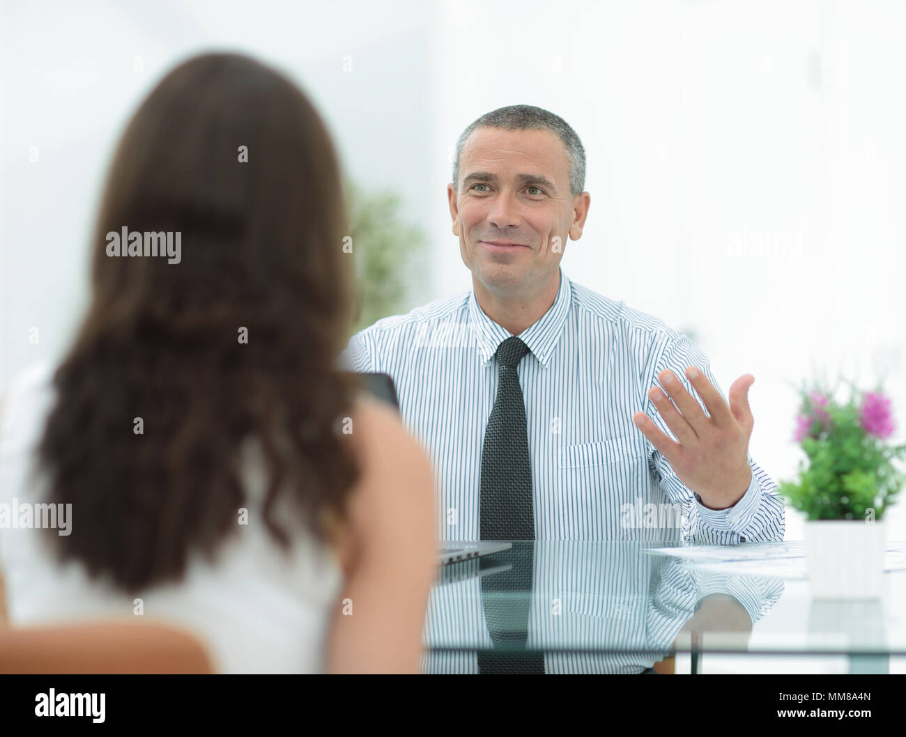 business consultant sits at his Desk and consult with their client ...