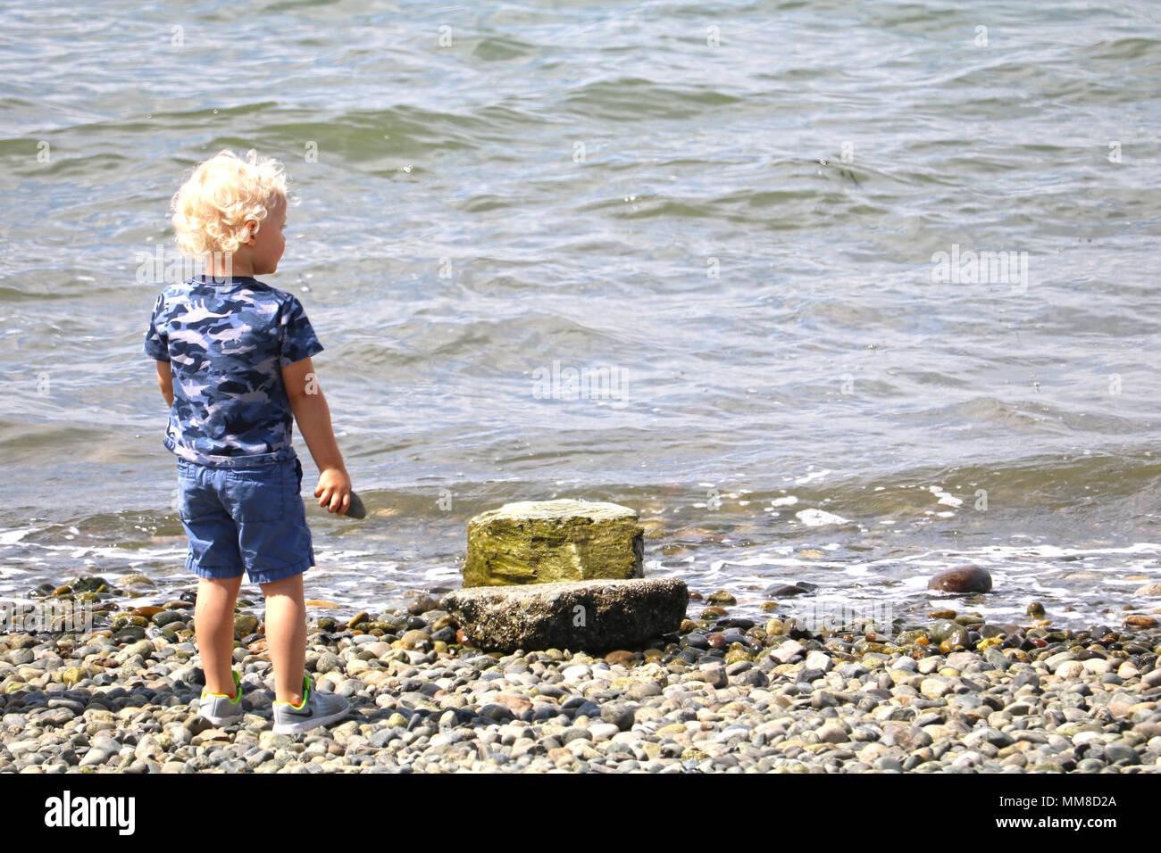 Boy throwing stones hi-res stock photography and images - Alamy