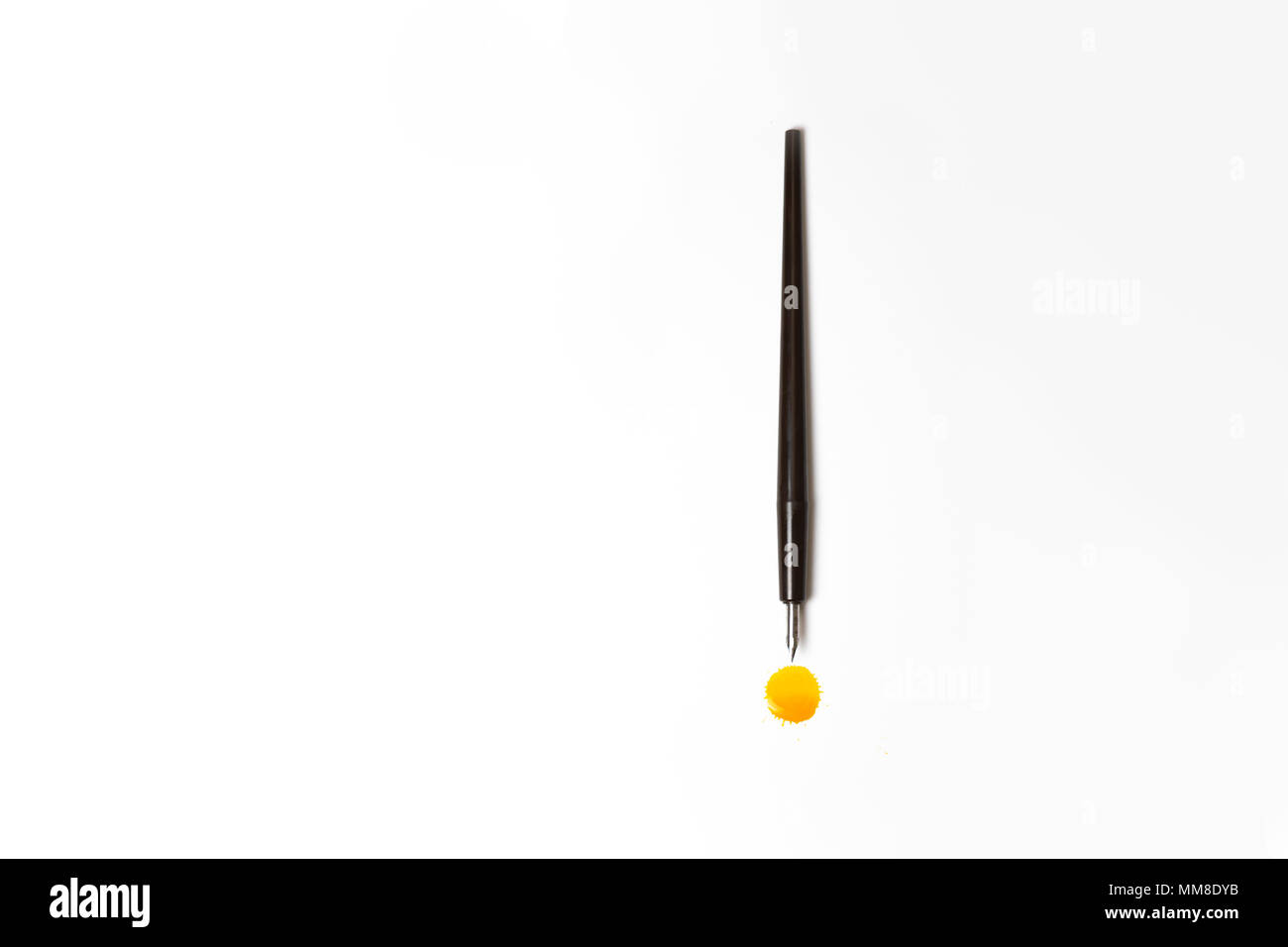 exclamation point formed from fountain pen and splattered yellow orange ...