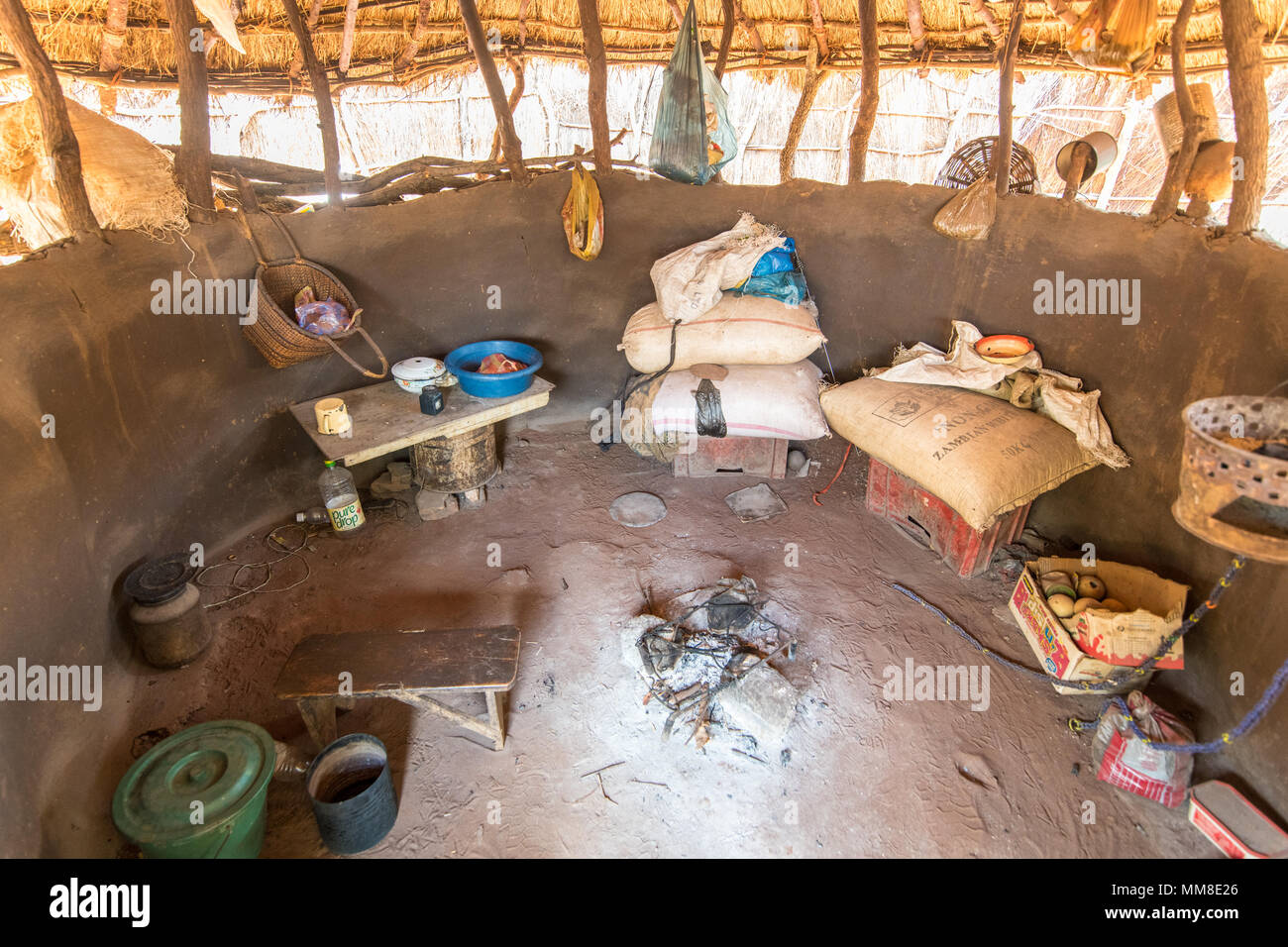 Interior of single-roomed hut with burnt out campfire in the middle ...