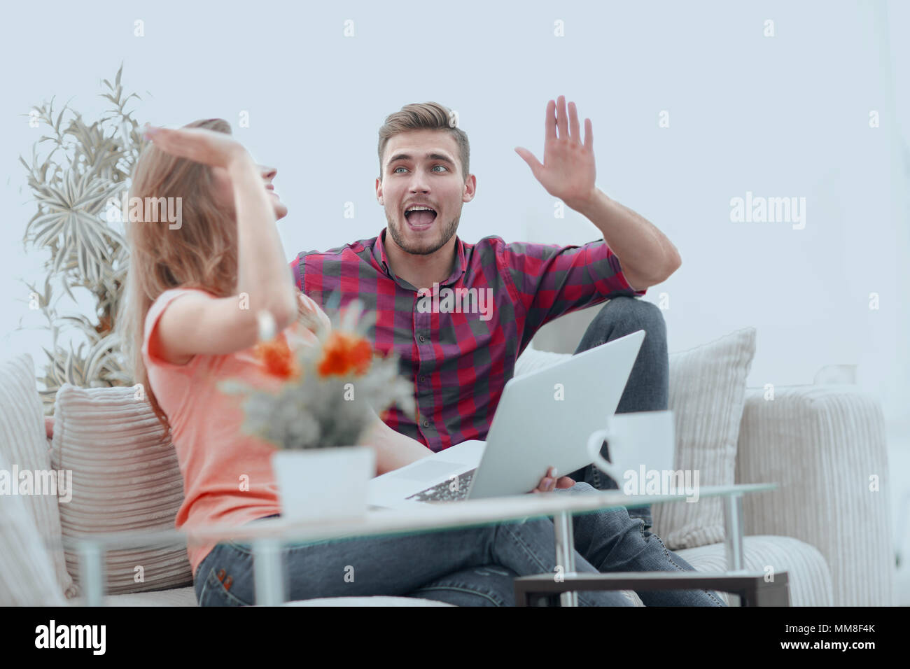 happy young couple giving each other a high five Stock Photo - Alamy