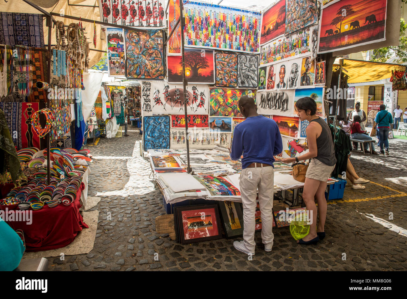 Buying and selling artwork for sale at the Green Market Square in Cape ...