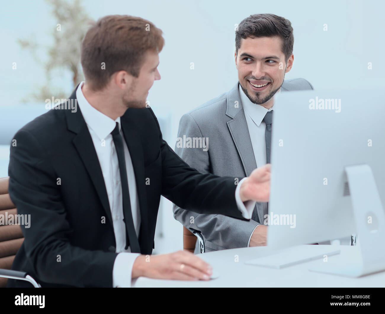 employees are talking sitting behind a Desk. office life Stock Photo ...