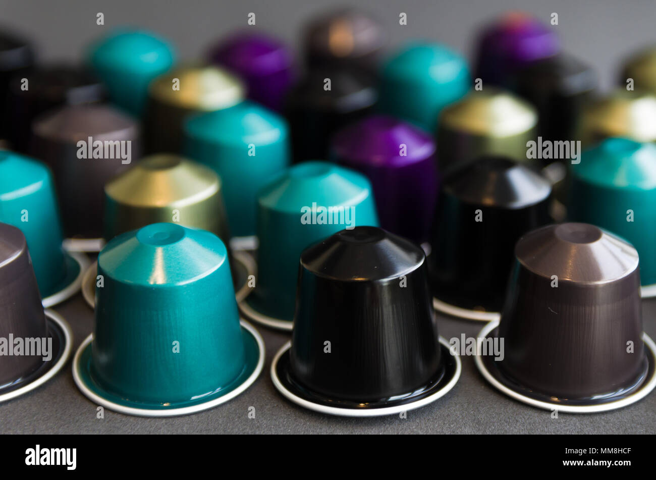 Beautiful colored coffee capsules on black background Stock Photo - Alamy