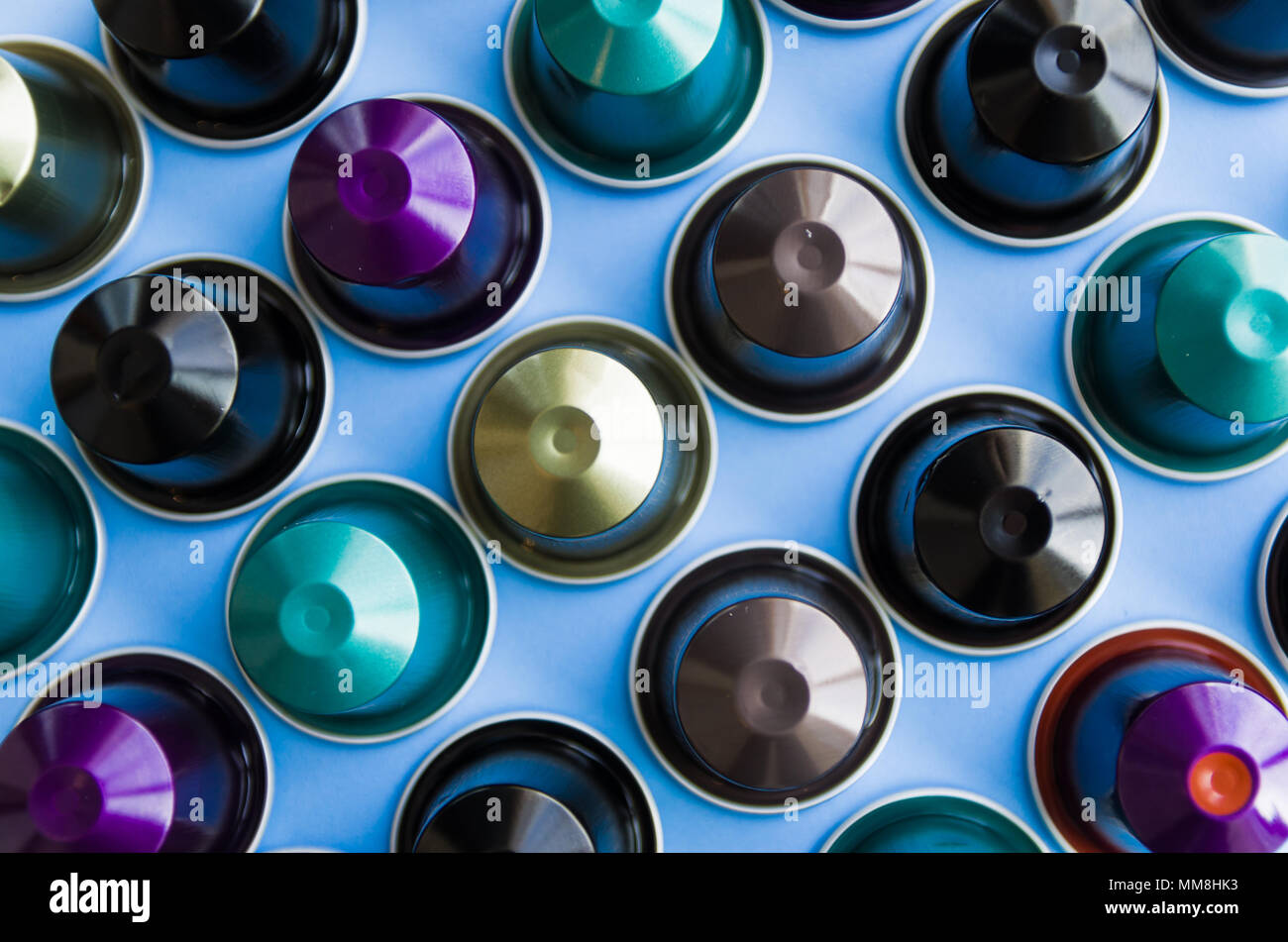 Beautiful colored coffee capsules on light blue background Stock Photo ...