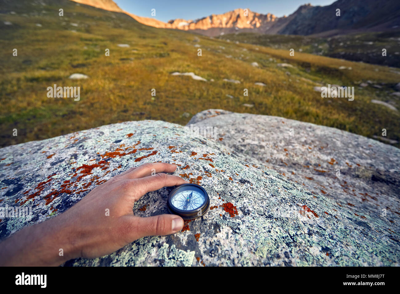 Tourist hand with vintage compass on the mountains background. Travel ...