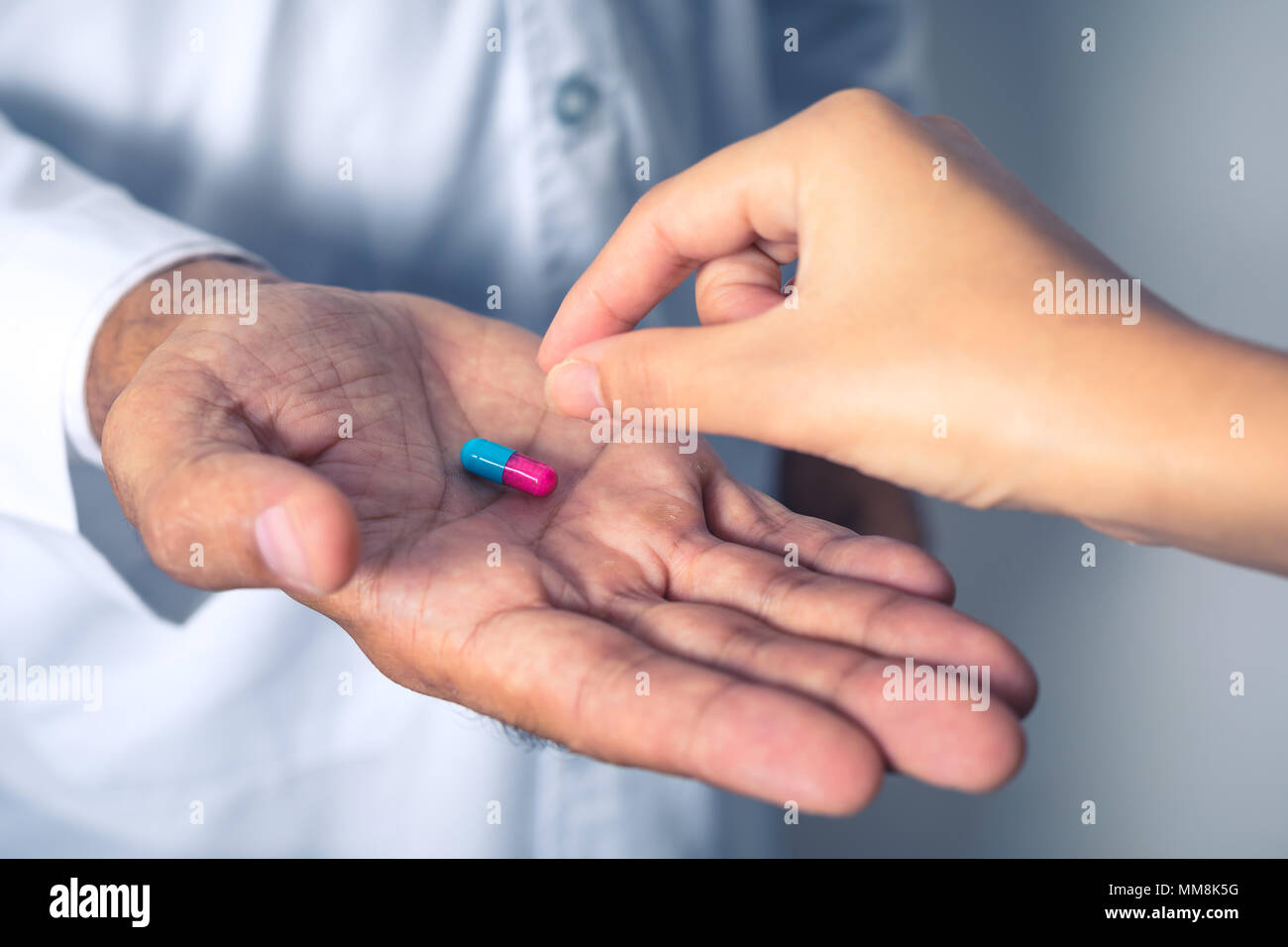 hand of doctor giving medicine to the patient Stock Photo - Alamy