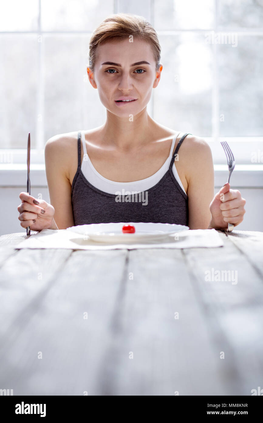 Nice pale woman holding a fork and knife Stock Photo - Alamy