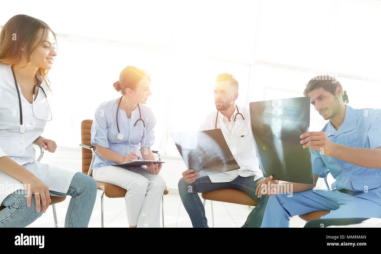 group of surgeons and medical professional staff discussing on patient ...