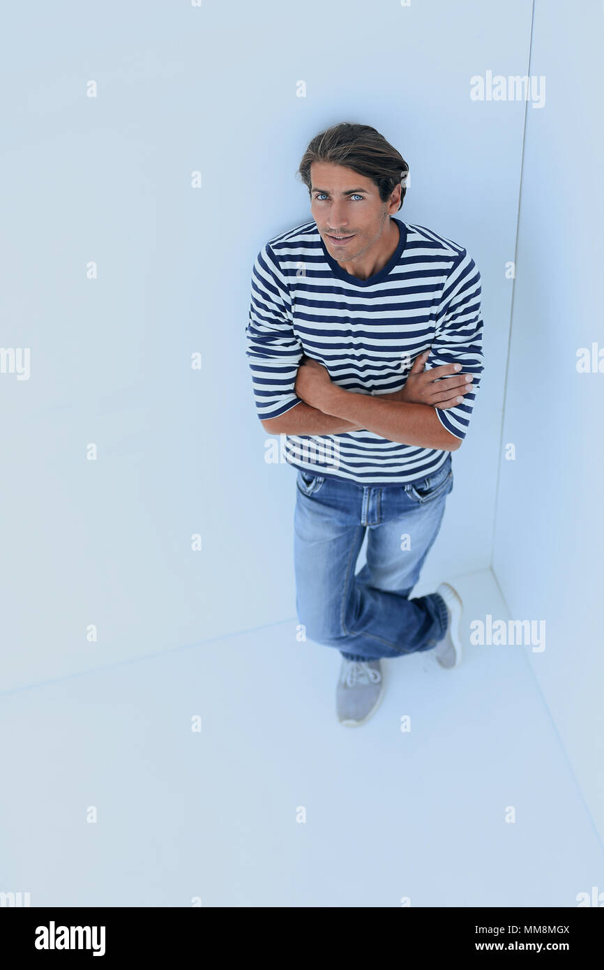 handsome guy standing near the white wall Stock Photo - Alamy