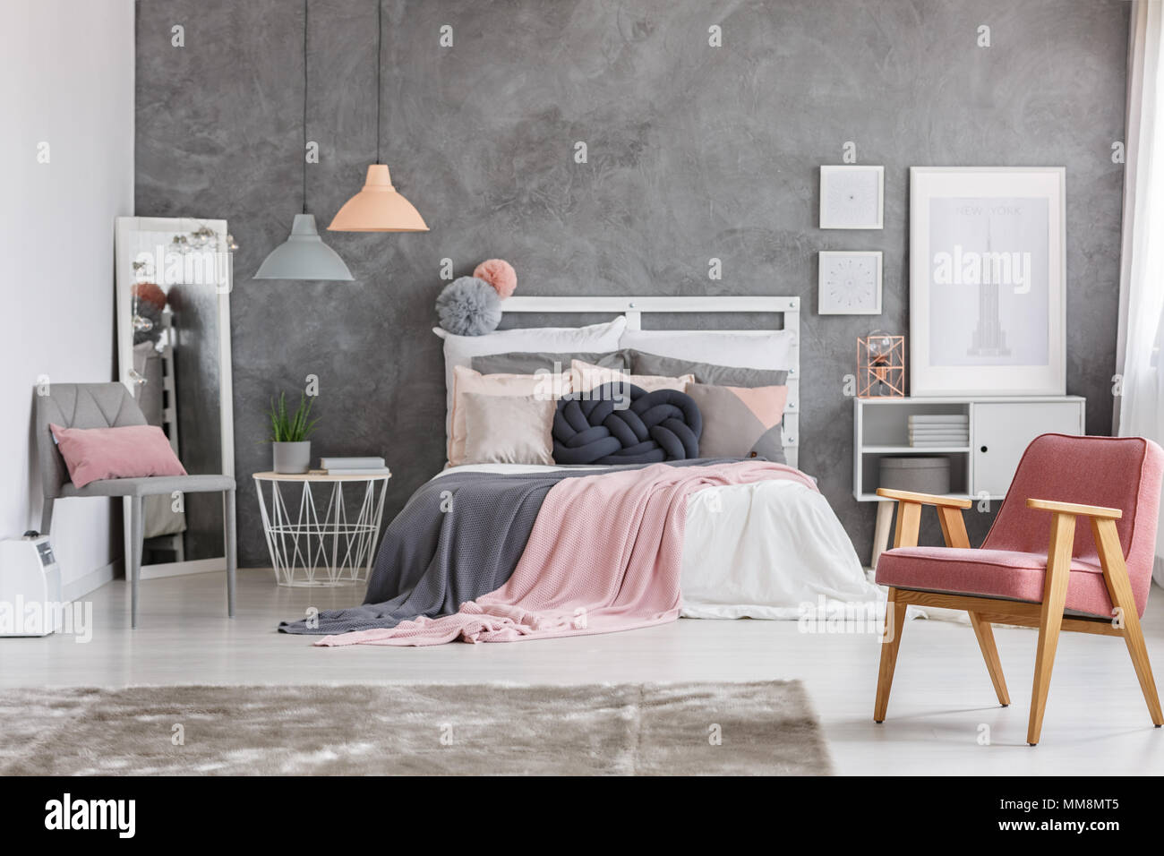 Two blankets in pastel colors falling off the wooden bed Stock Photo ...