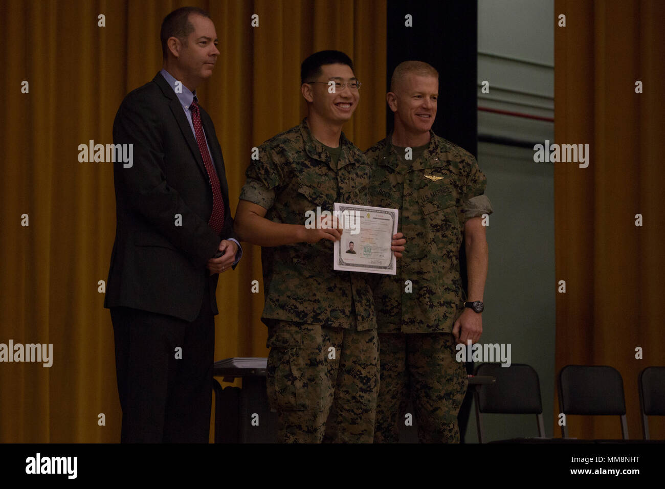 CAMP FOSTER, OKINAWA, Japan—Thomas Curley, left, Cpl. Bohou Li, center ...