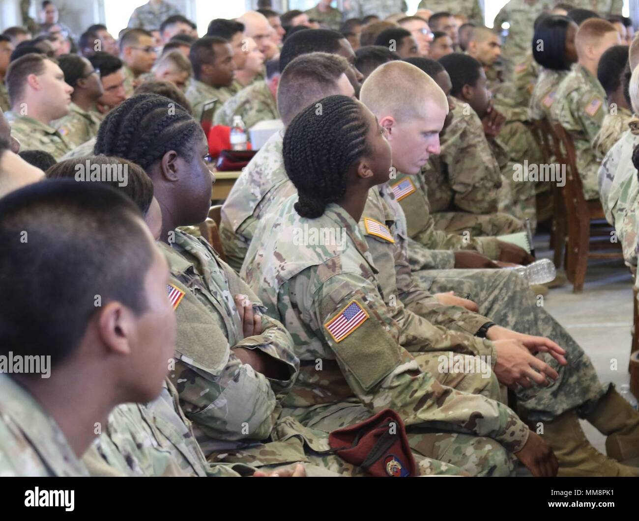 Soldiers with the 82nd Airborne Division listen to an in-processing ...