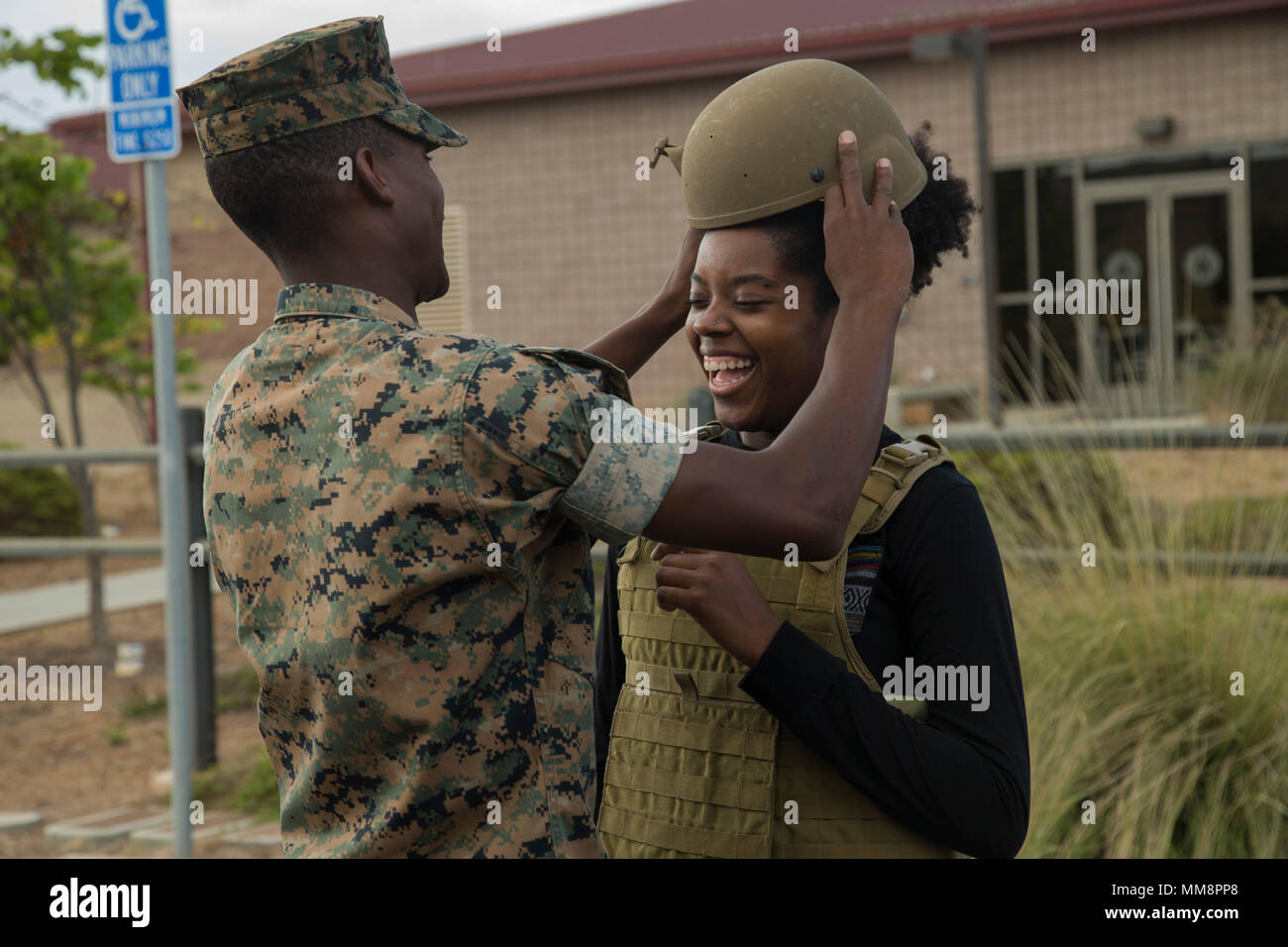 U. S. Marines with 1st Marine Raider Support Battalion assist family ...