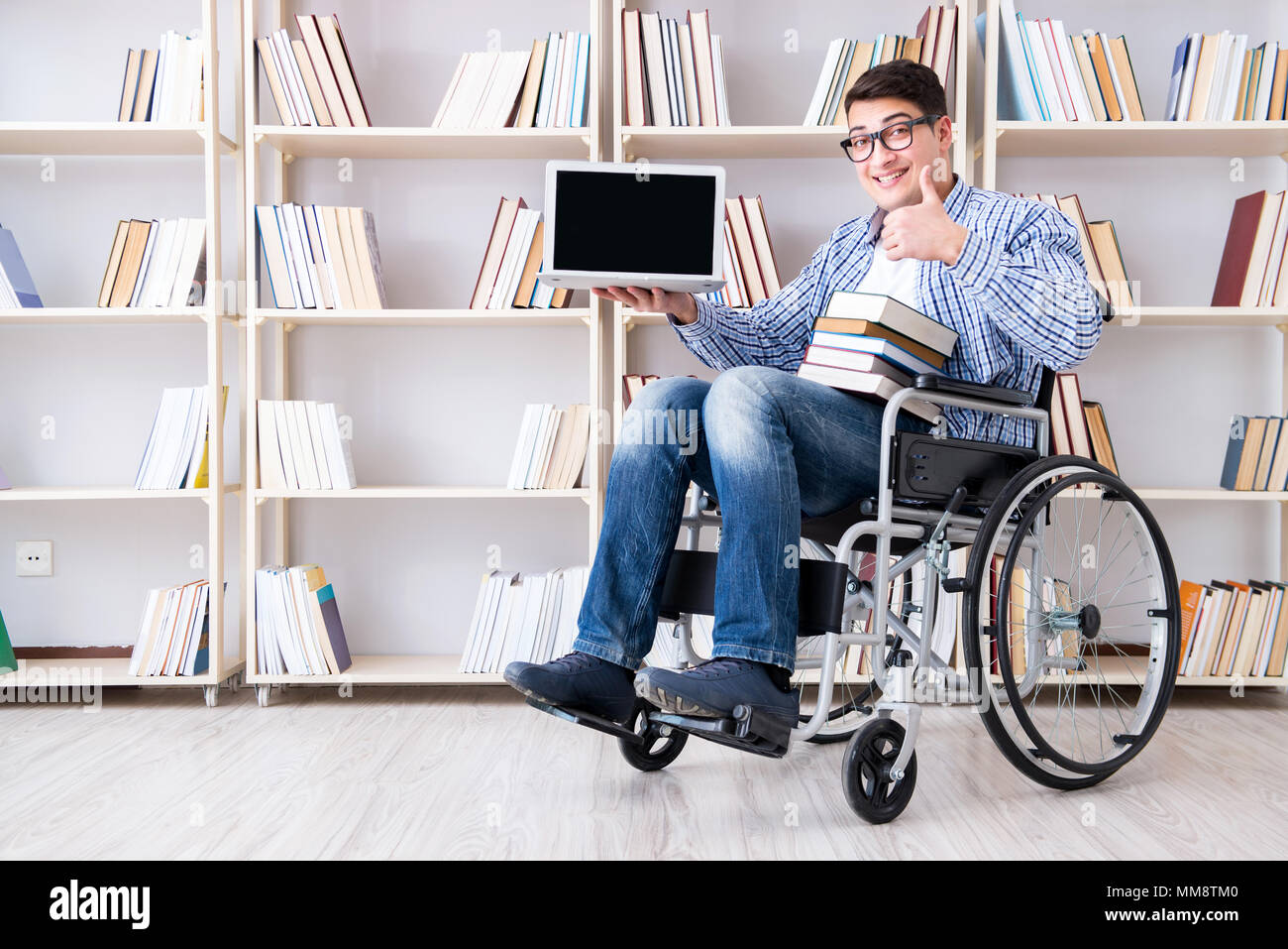 Disabled student studying in the library Stock Photo - Alamy