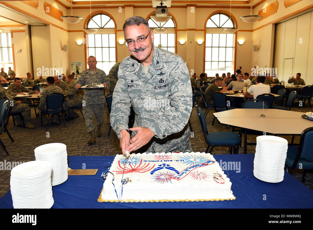 Col. Daniel Whipple, commander of the 127th Mission Support Group, cuts ...