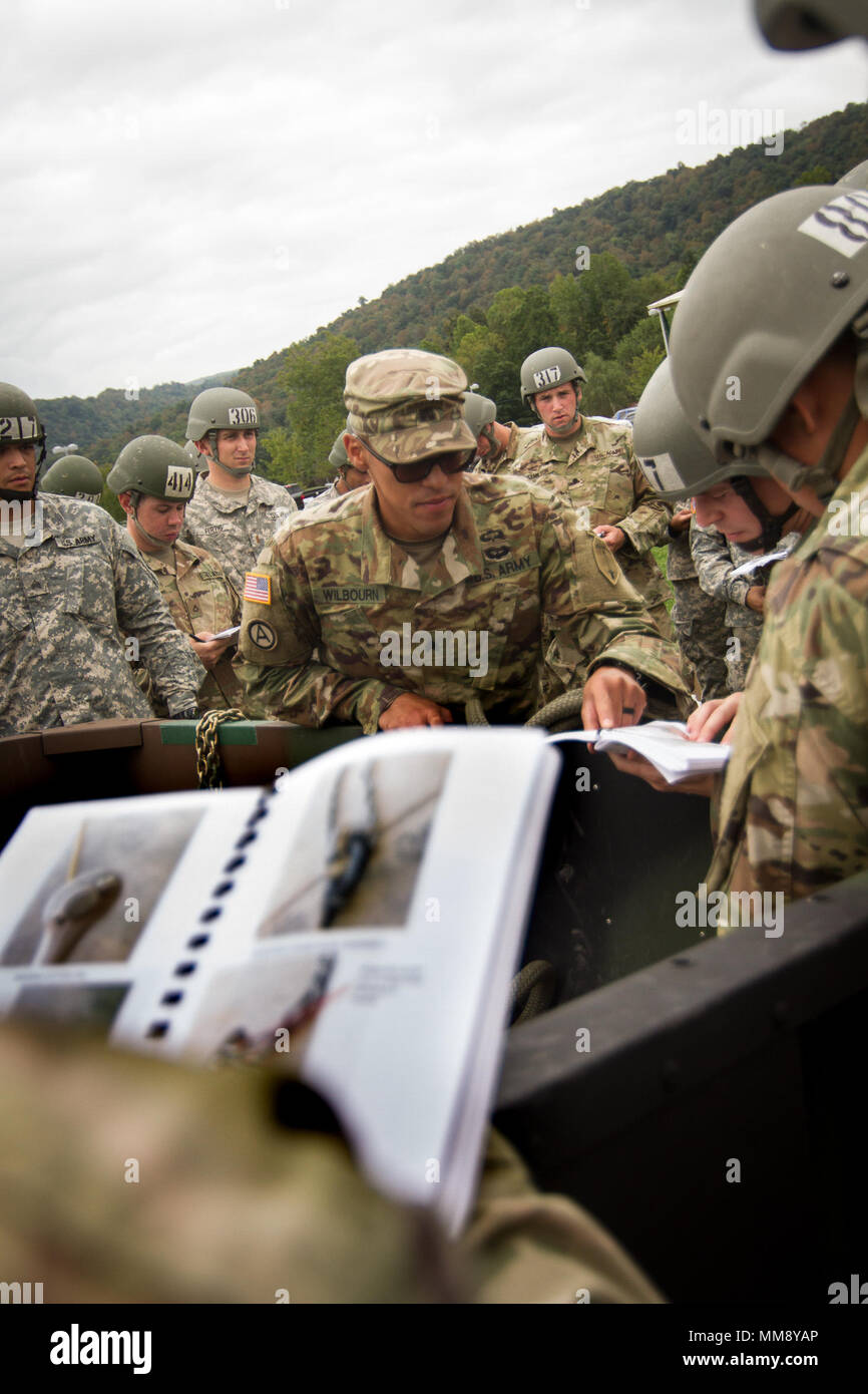 Air Assault Cadre, Sgt Cedric Wilbourn, helps students check on ...