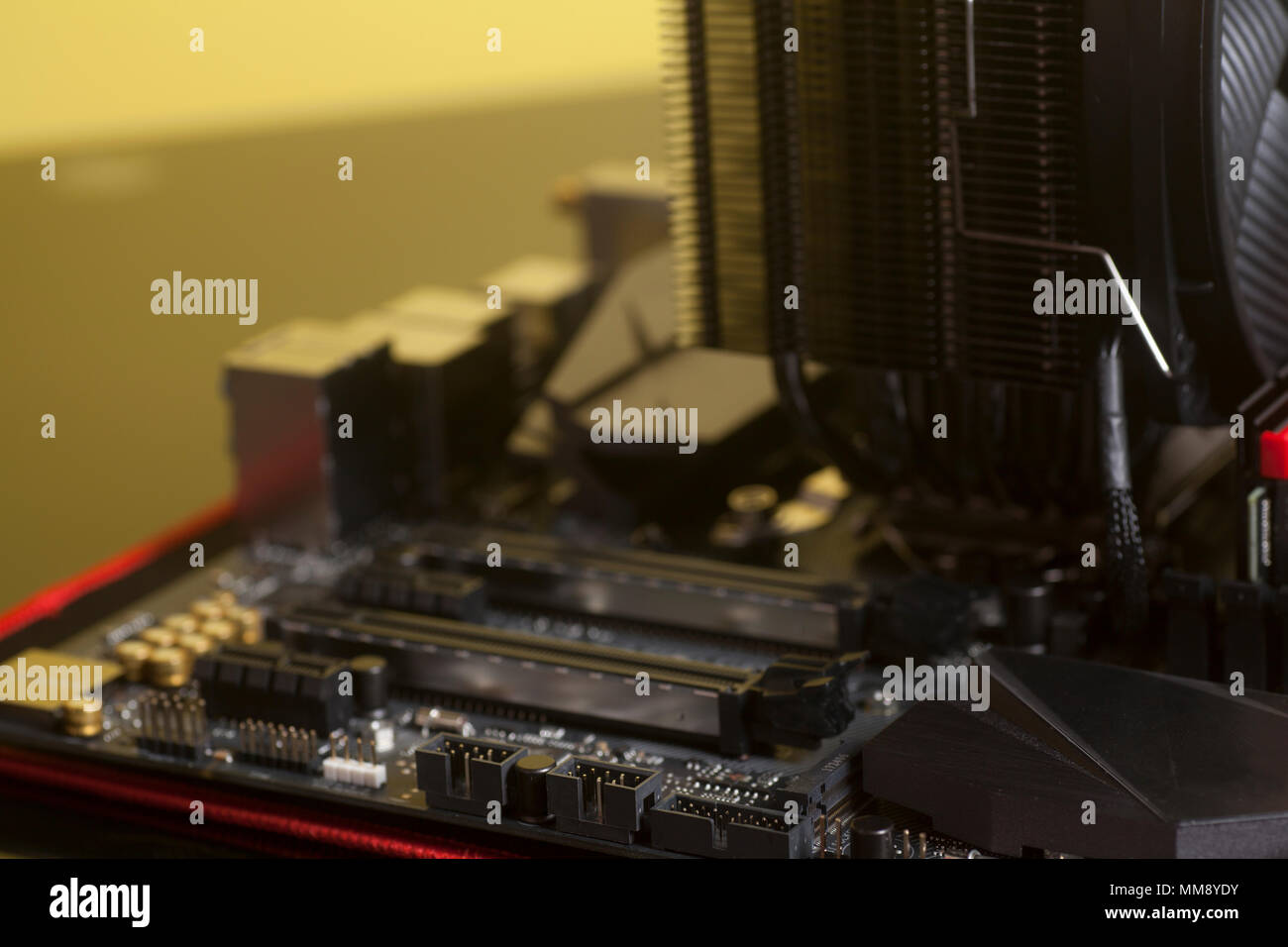 Motherboard computer circuit with CPU fan processor cooler on yellow ...