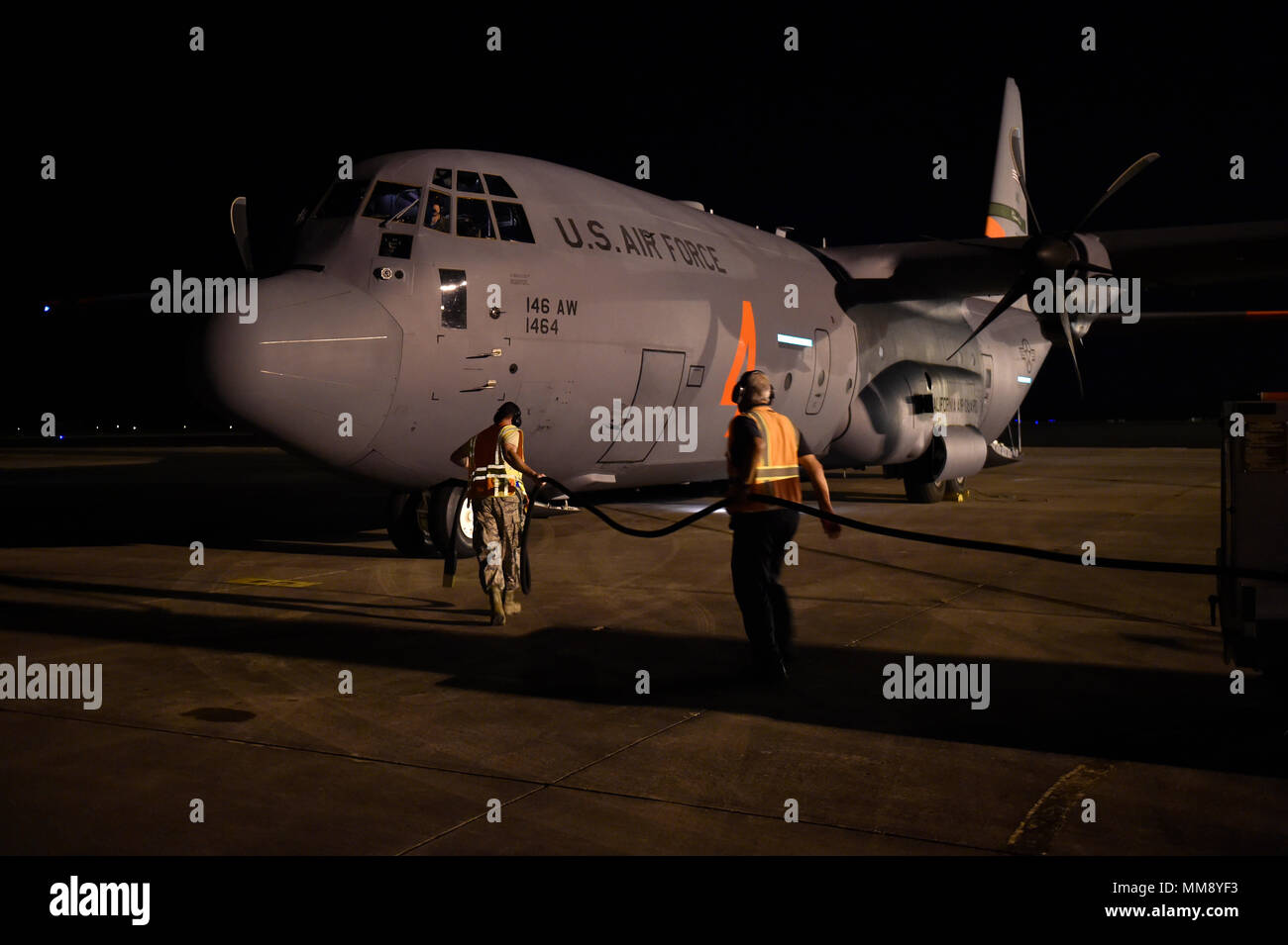 Personnel from the transient alert team connect an external power unit ...