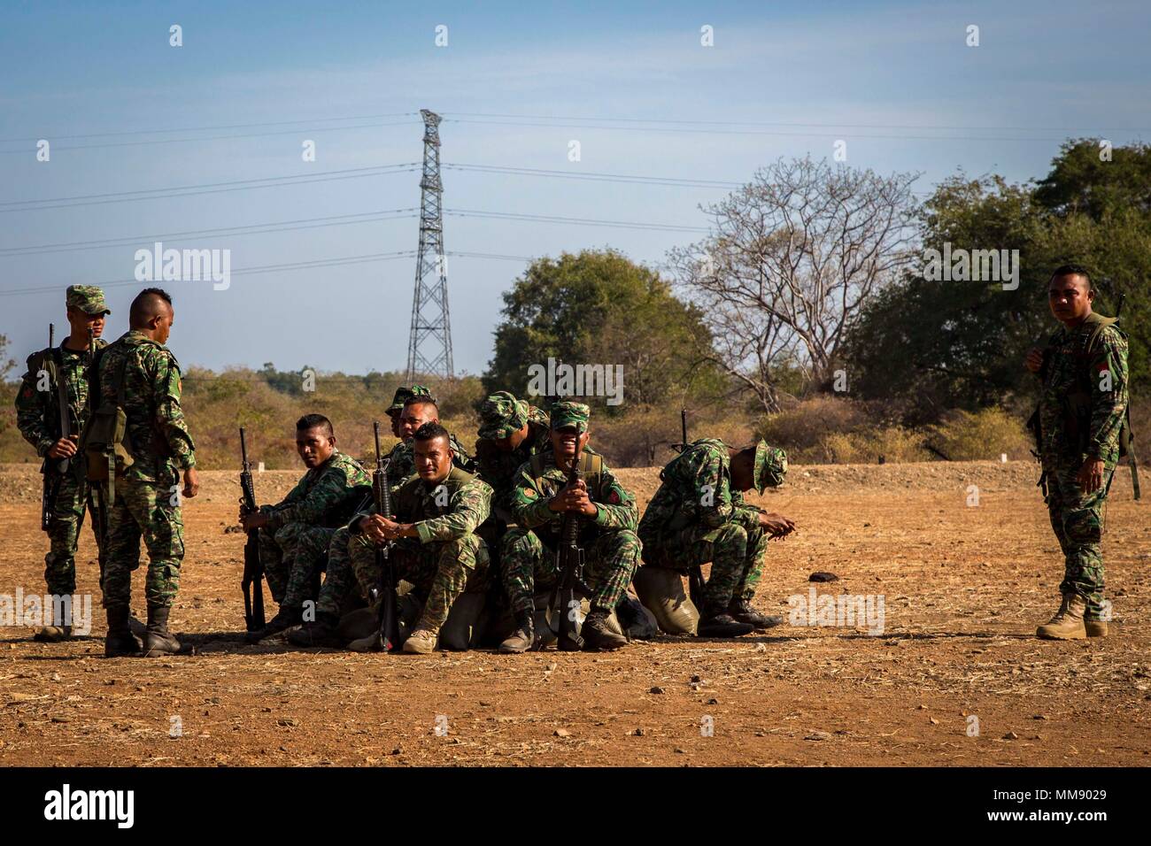 Members of the Falantil Forca de Defensa Timor Leste sit at a live fire ...