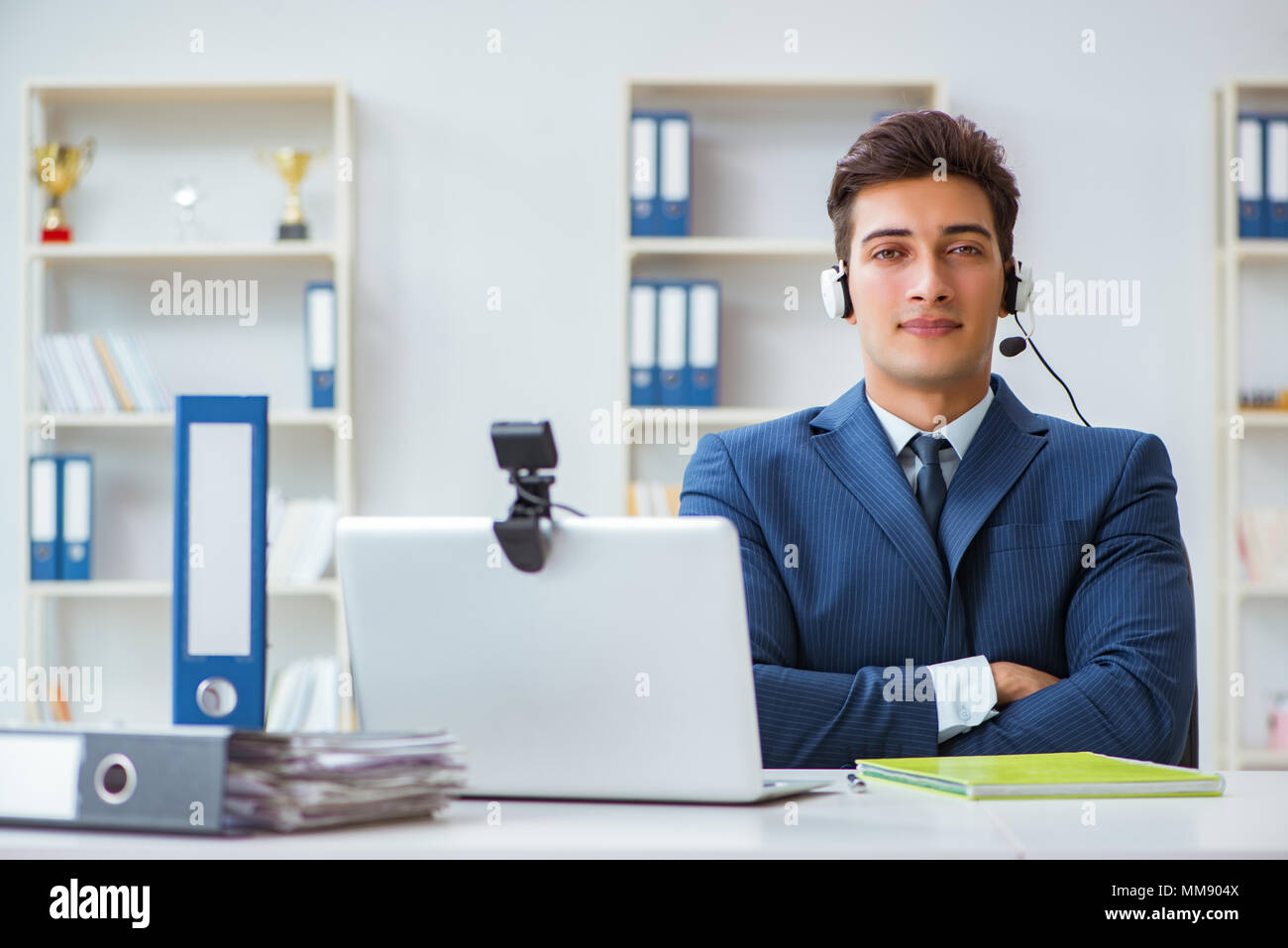 Young help desk operator working in office Stock Photo - Alamy