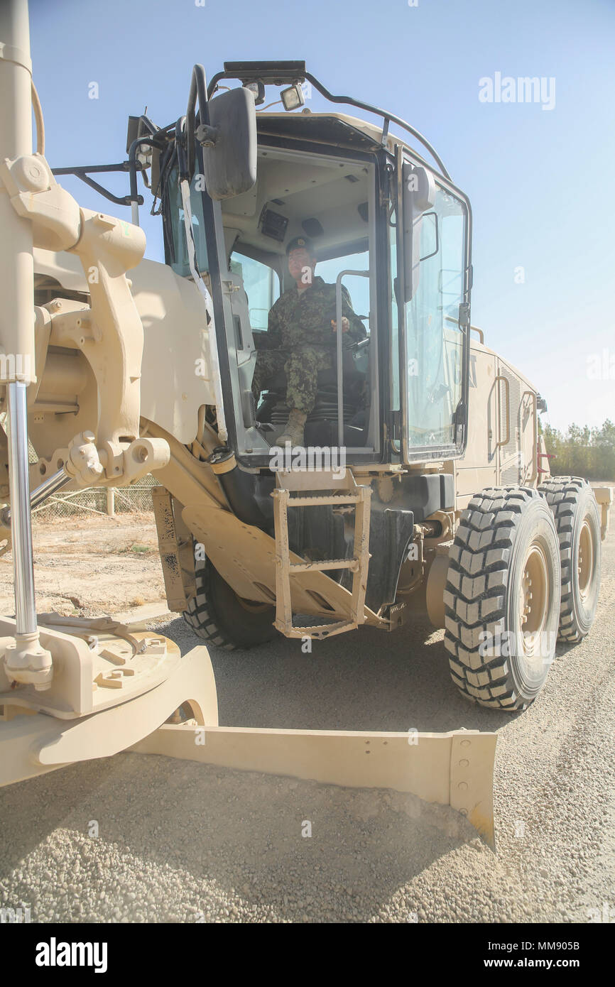 An Afghan National Army engineer soldier with 215th Corps levels a road ...