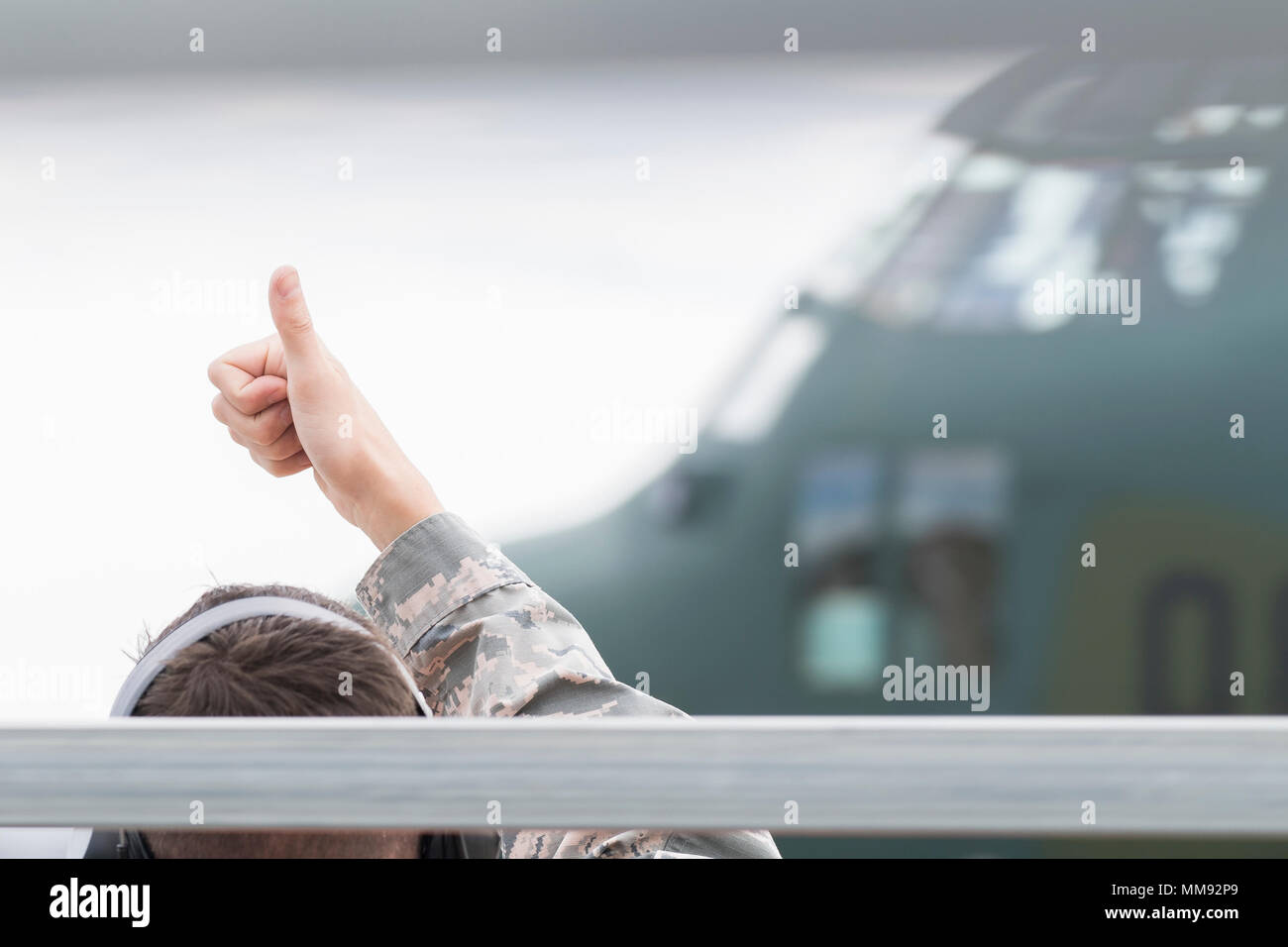 A 374th Maintenance Squadron transient alert technician gives a thumbs ...