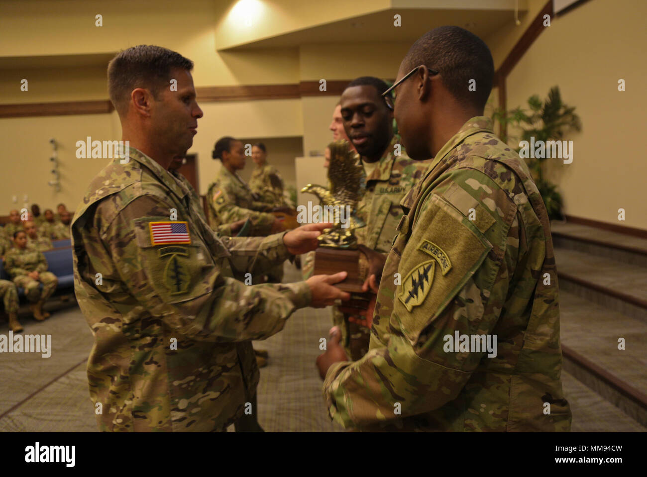 Col. Richard E. Angle presents Sgt. Mark Knight and Spc. Miles Powell ...