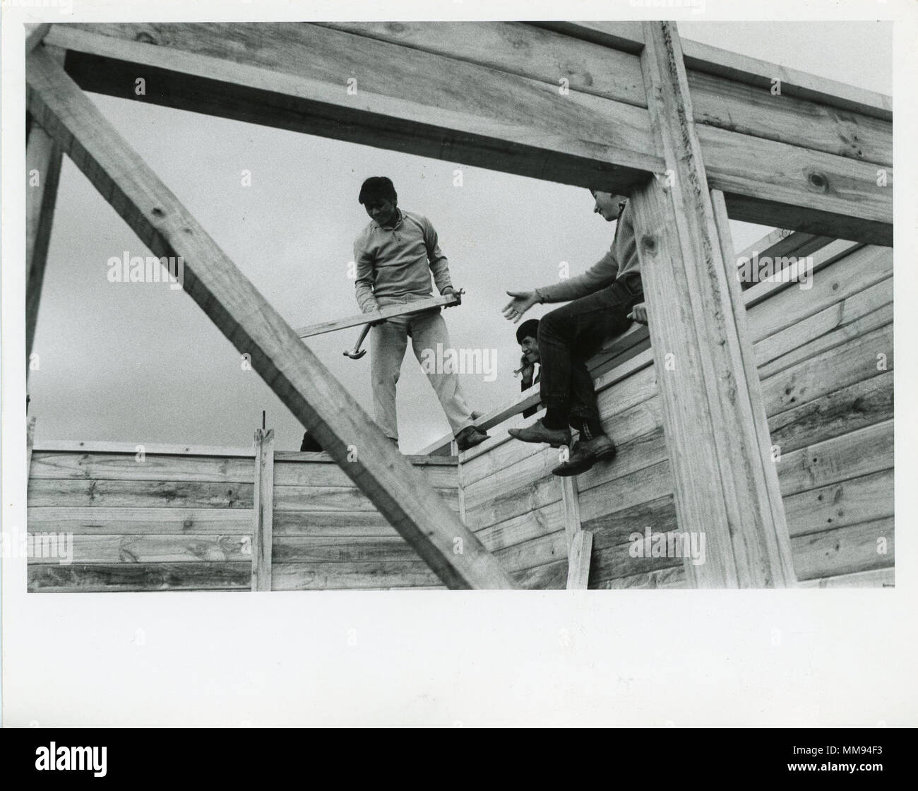 Snapshot of men laying wood for a building structure Stock Photo - Alamy