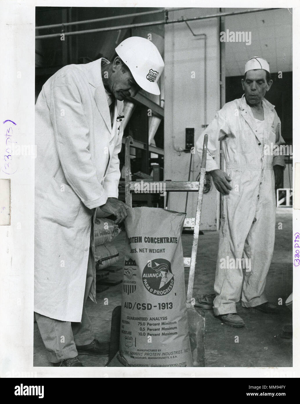 Snapshot of factory workers, bagging up food Stock Photo - Alamy