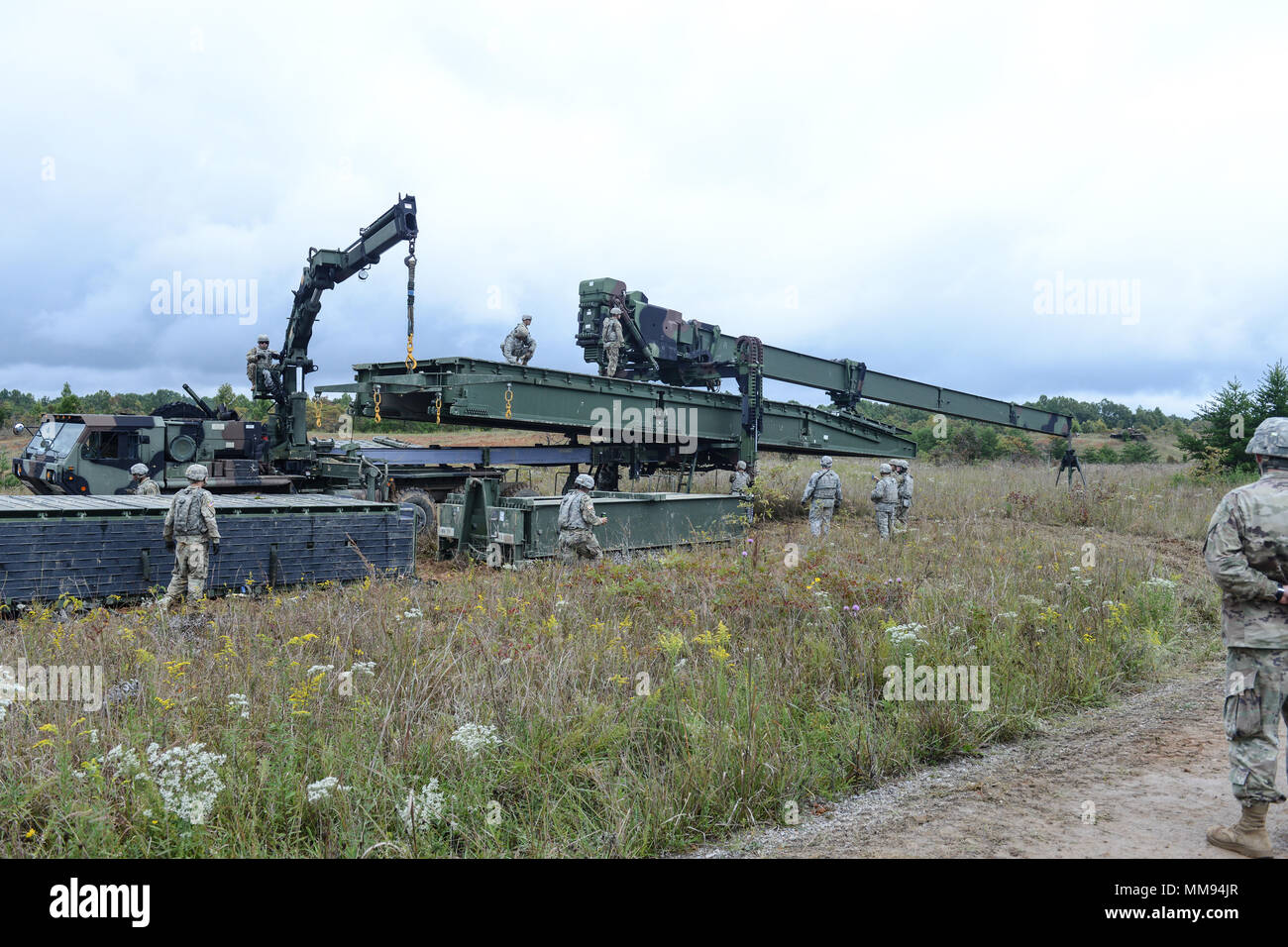 Members of the 19th Engineers Battalion assemble and set a land bridge ...