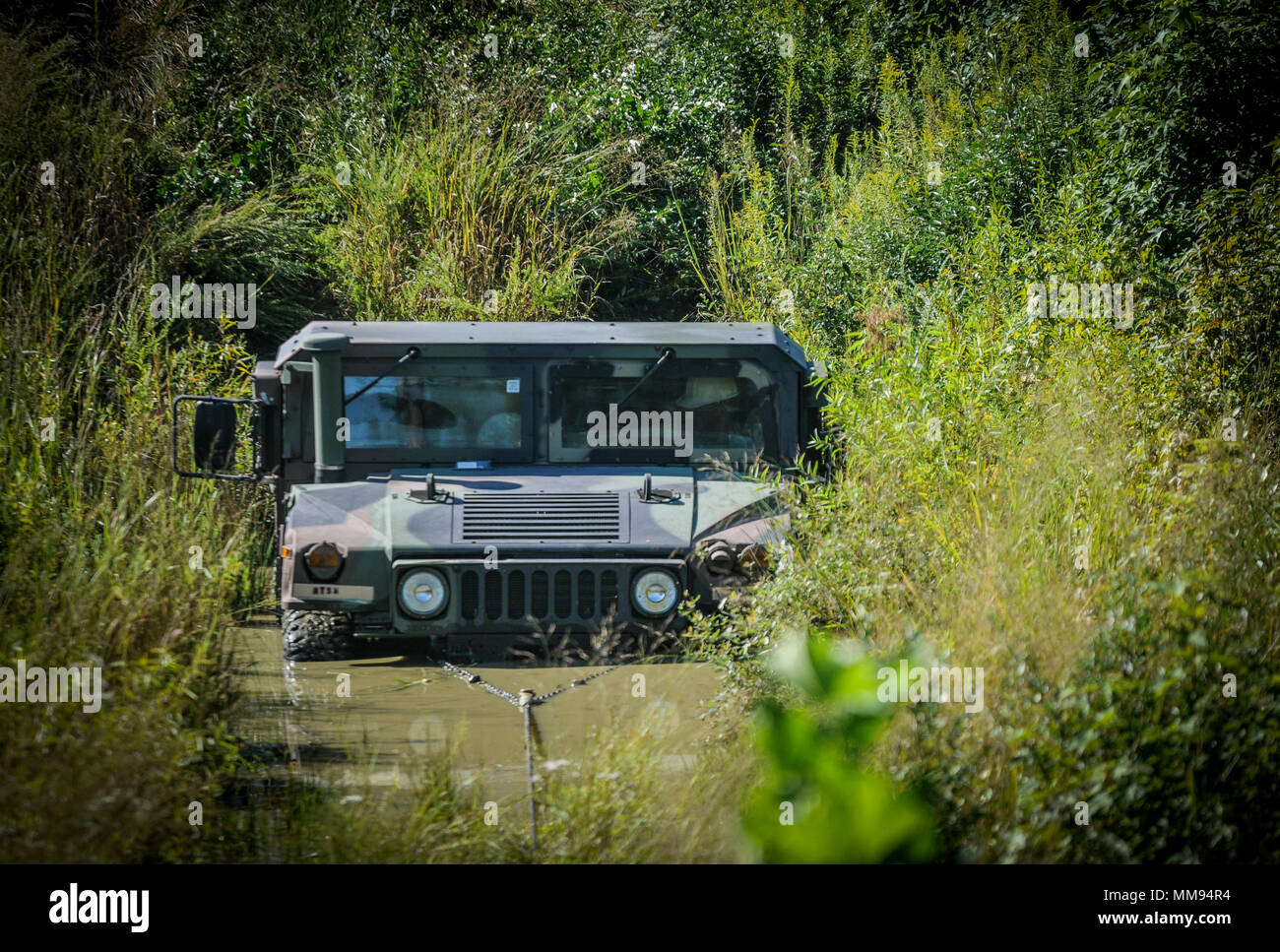 A Humvee gets pulled out of the mud pit during the 91-B Wheeled Vehicle ...