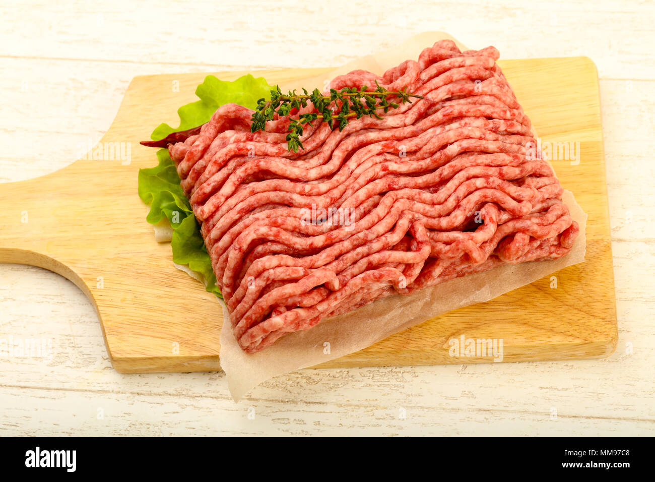 Raw minced beef meat with thyme and hot pepper Stock Photo - Alamy