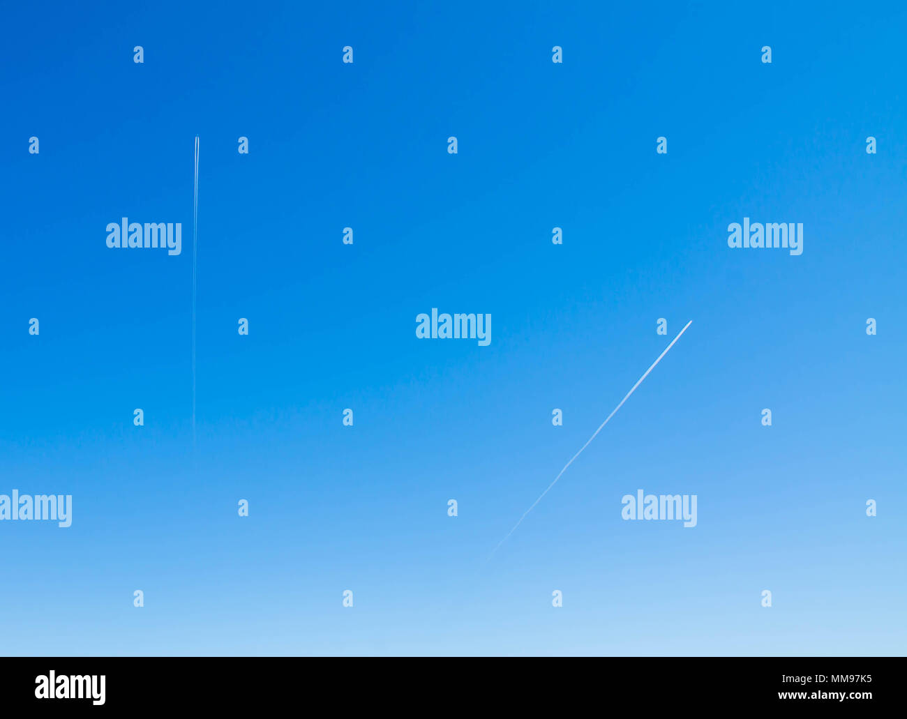 two planes fly high in the blue sky Stock Photo - Alamy