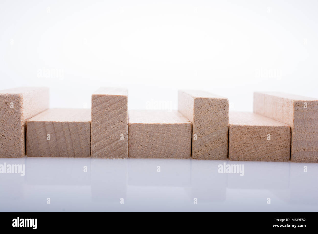 Wooden Domino Blocks in a line on a white background Stock Photo - Alamy