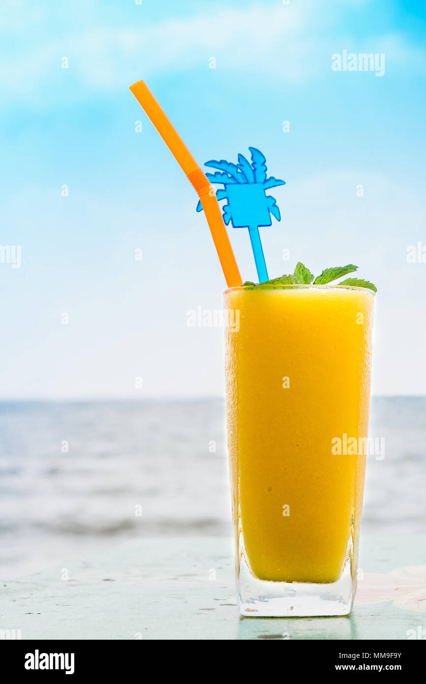 Mango shake with straw on the tropical beach Stock Photo - Alamy
