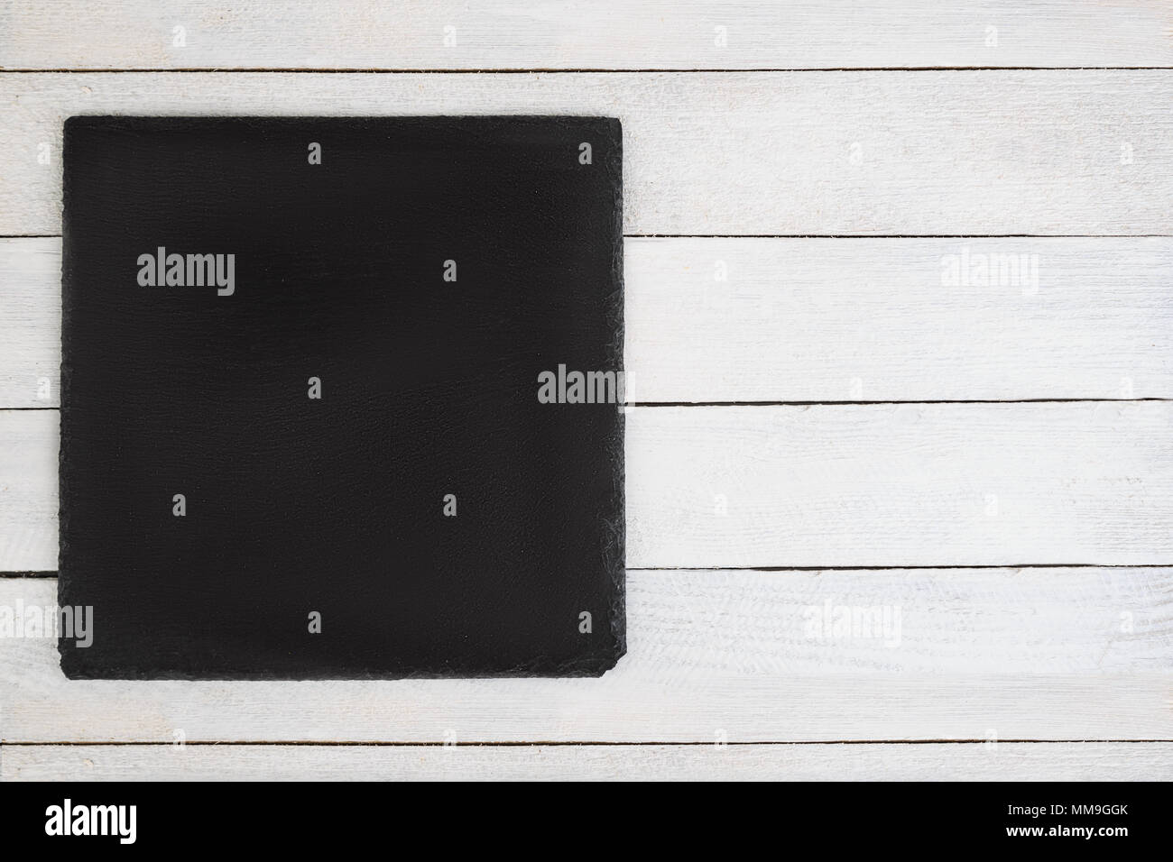 Slate board on a wooden background Stock Photo - Alamy