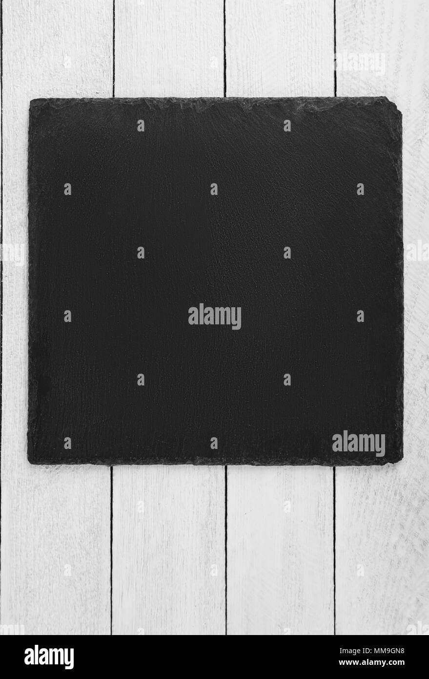 Blackboard on wooden background Black and White Stock Photos & Images ...