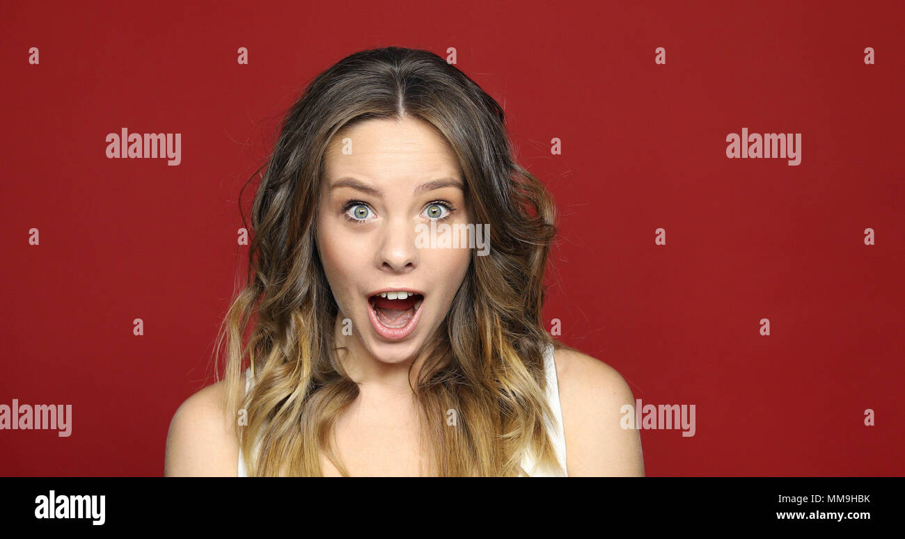 Female Face in Shock on red Close Up Stock Photo - Alamy