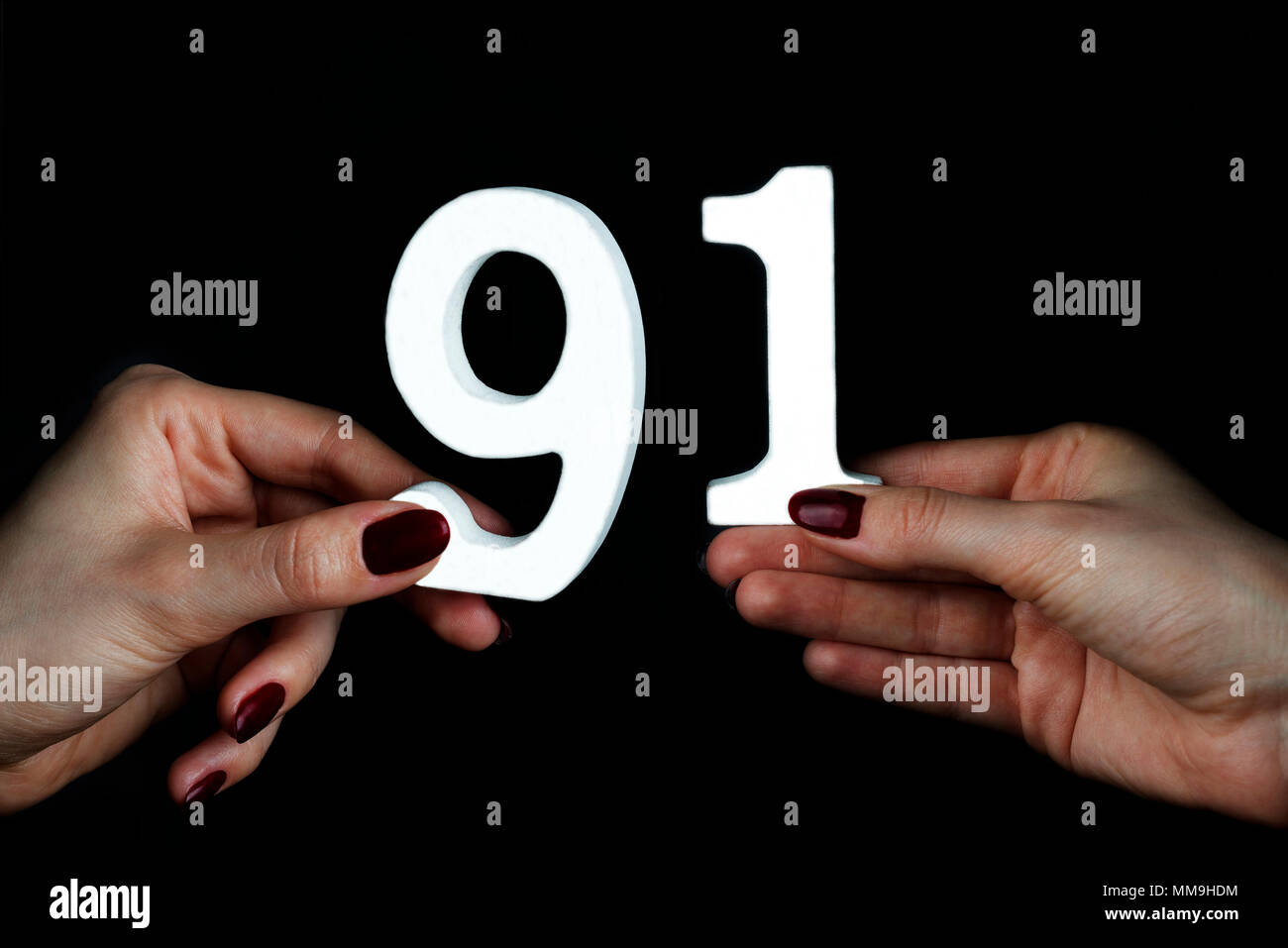 On a black background, female hand with numbers ninety-one Stock Photo ...