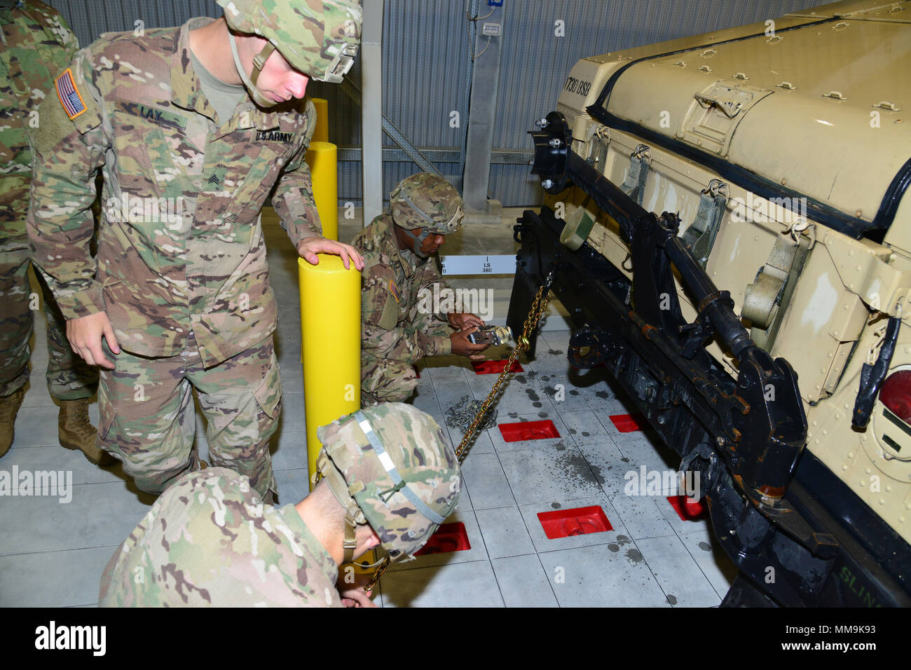 A High Mobility Multipurpose Wheeled Vehicle (HMMWV) is loaded into a C ...